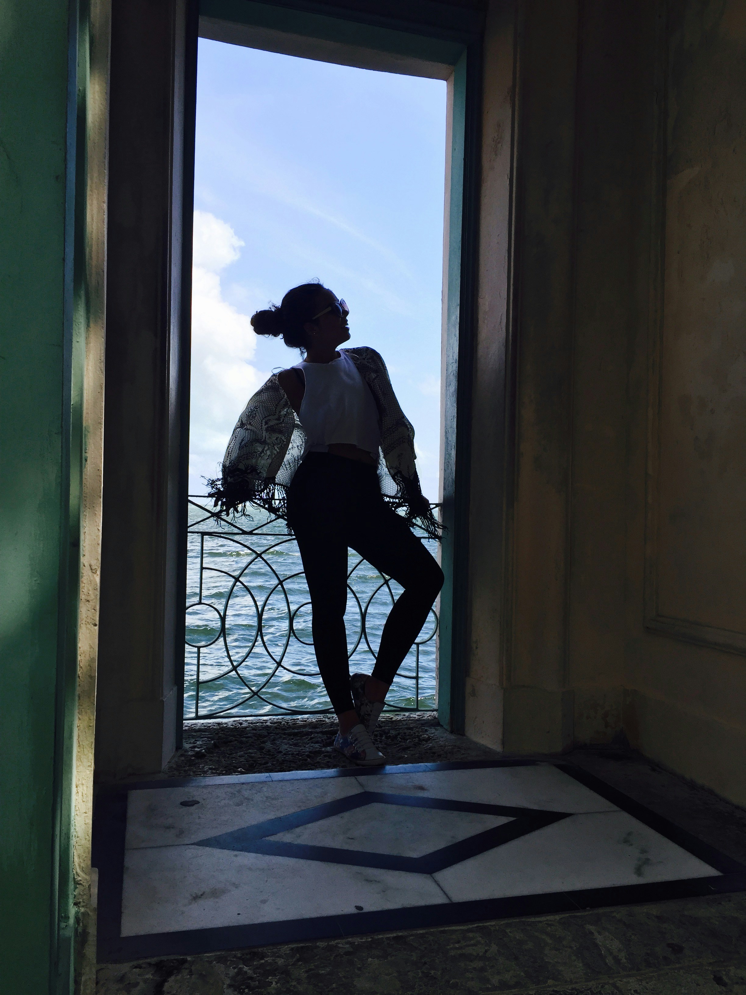 Silhouette at Sea Gate: A Pose by the Window