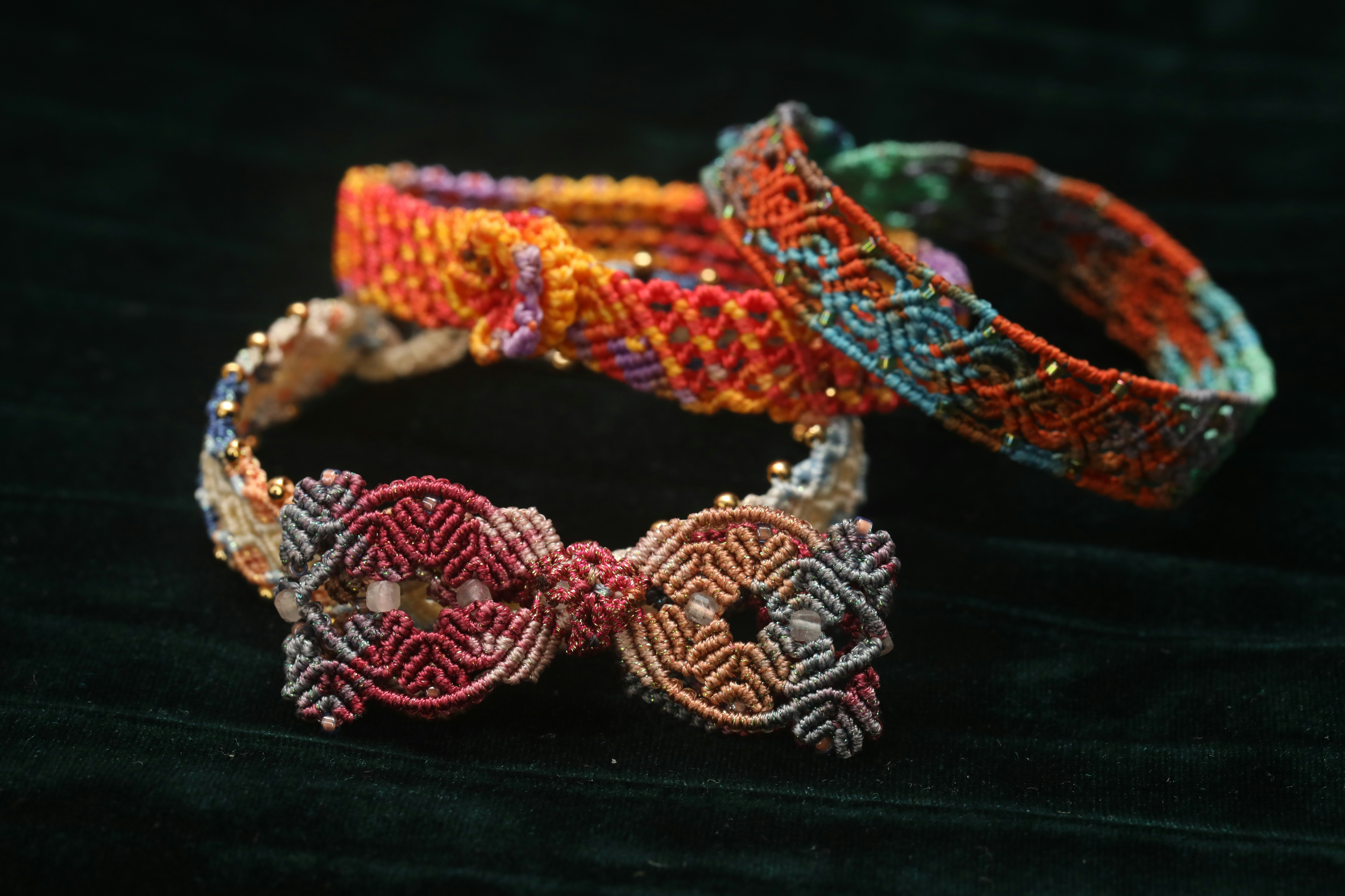Colorful Beaded Circles: Intertwined Bracelets on Velvet