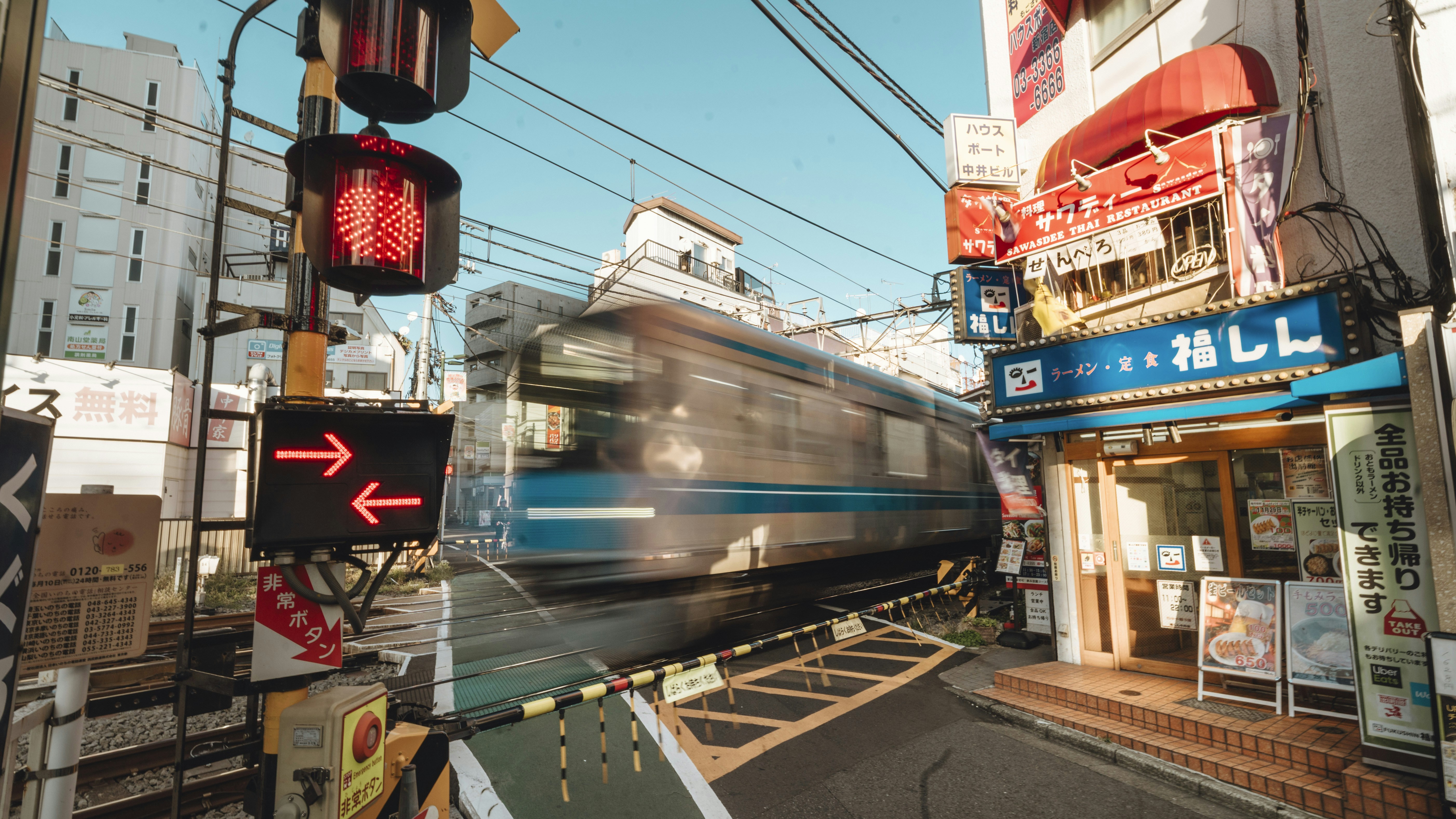 Motion at the Crossing: A Blue Train Blurs through a City Street