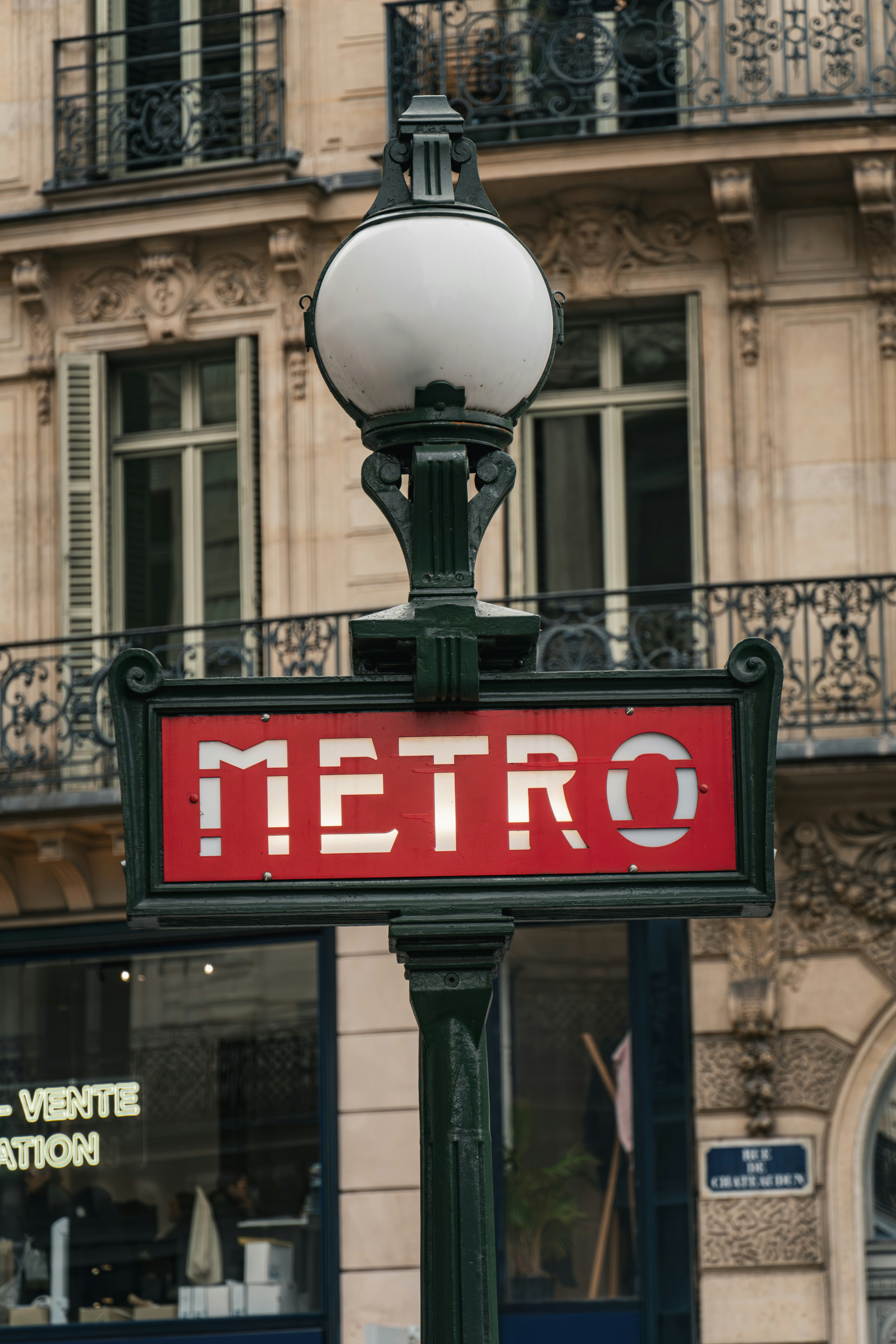 Metro Sign in Paris: A Timeless Street Lamp Framing the City