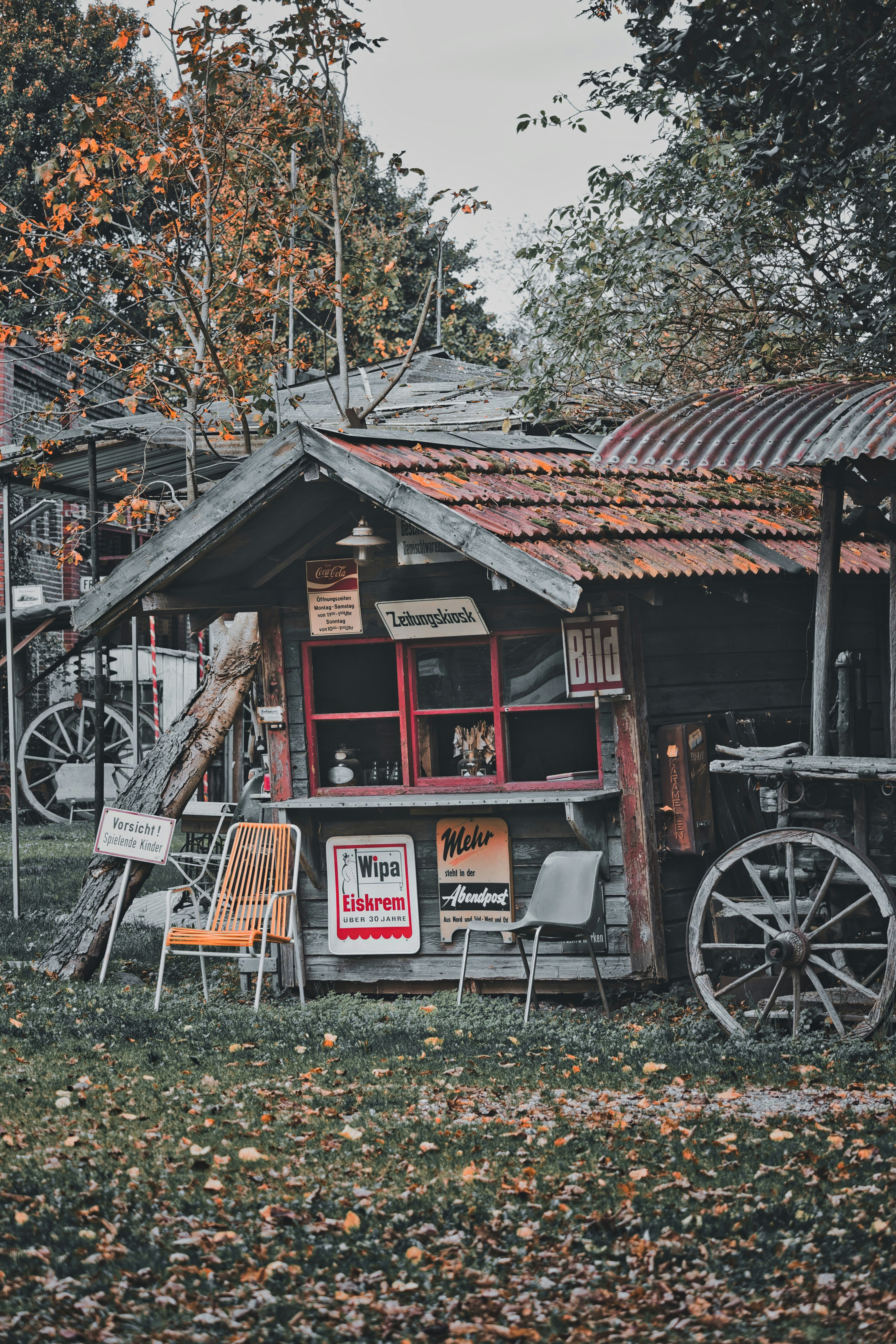 Rustic Stand at Dusk: A Quiet Alley of Signage and Wheels