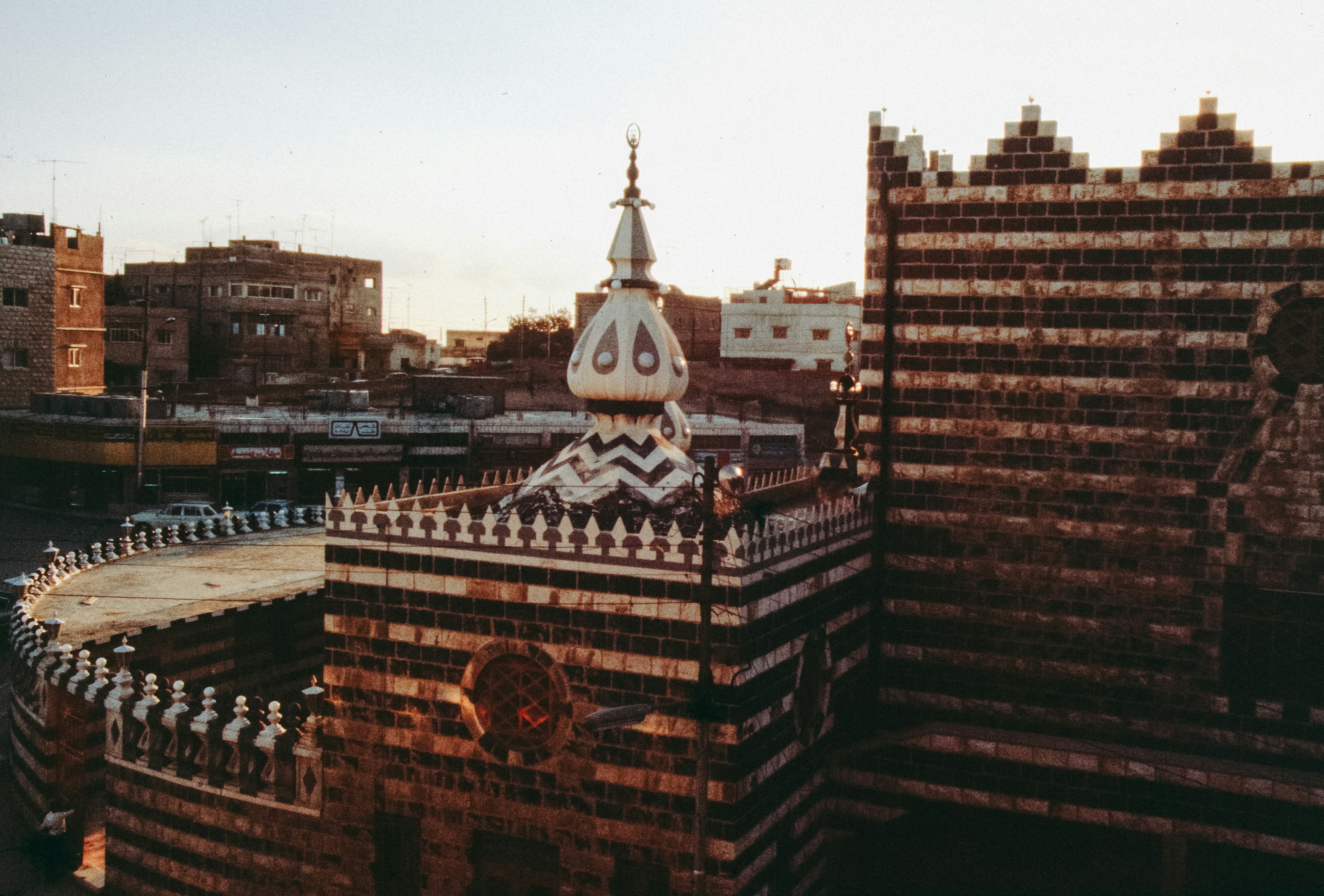 Mosaic Bell Tower Rising from Brick Red Fortifications