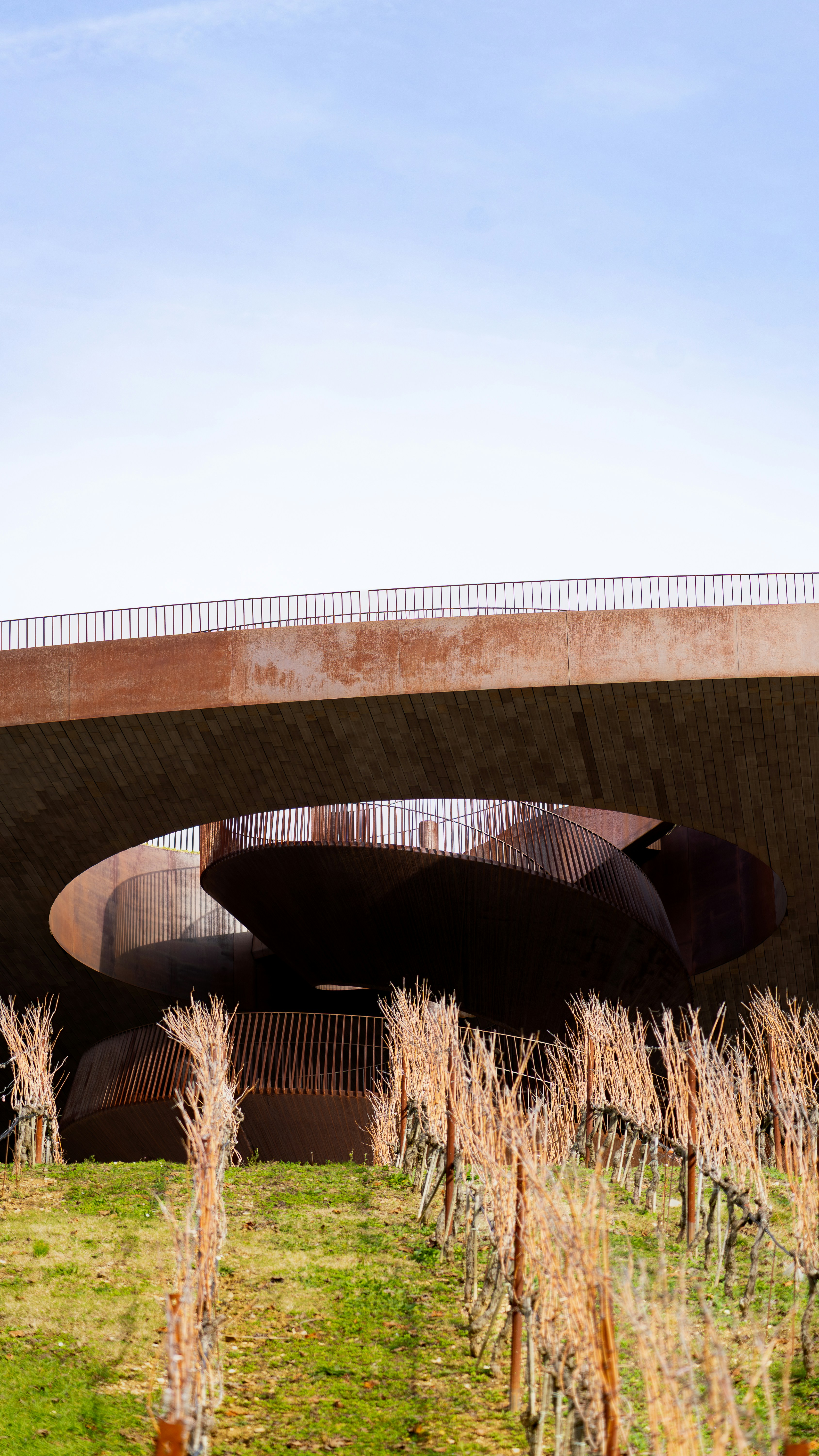 Spiral Staircase Beneath a Rusted Overpass
