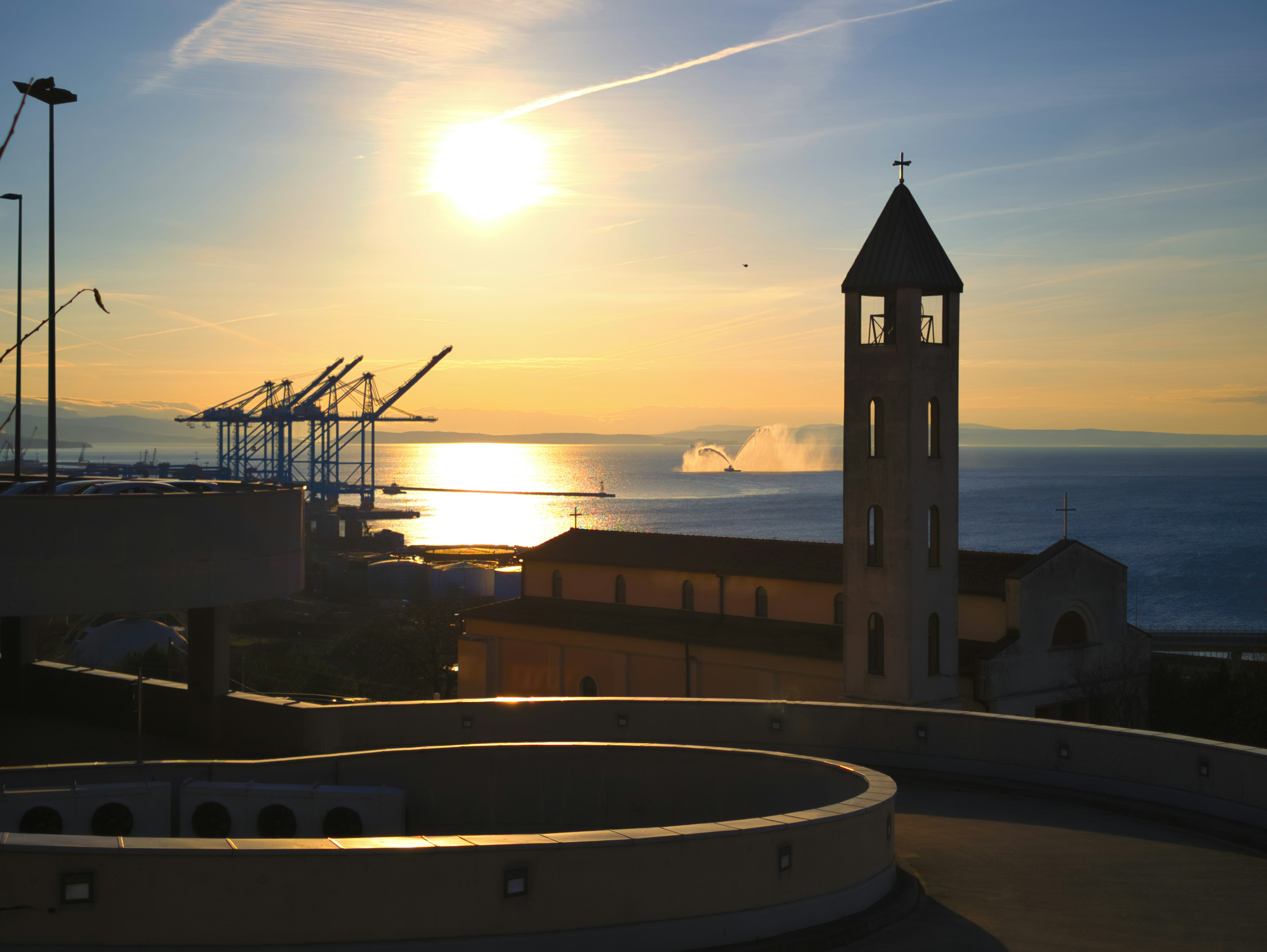 Sunlit Bell Tower Over a Seaside Terrace