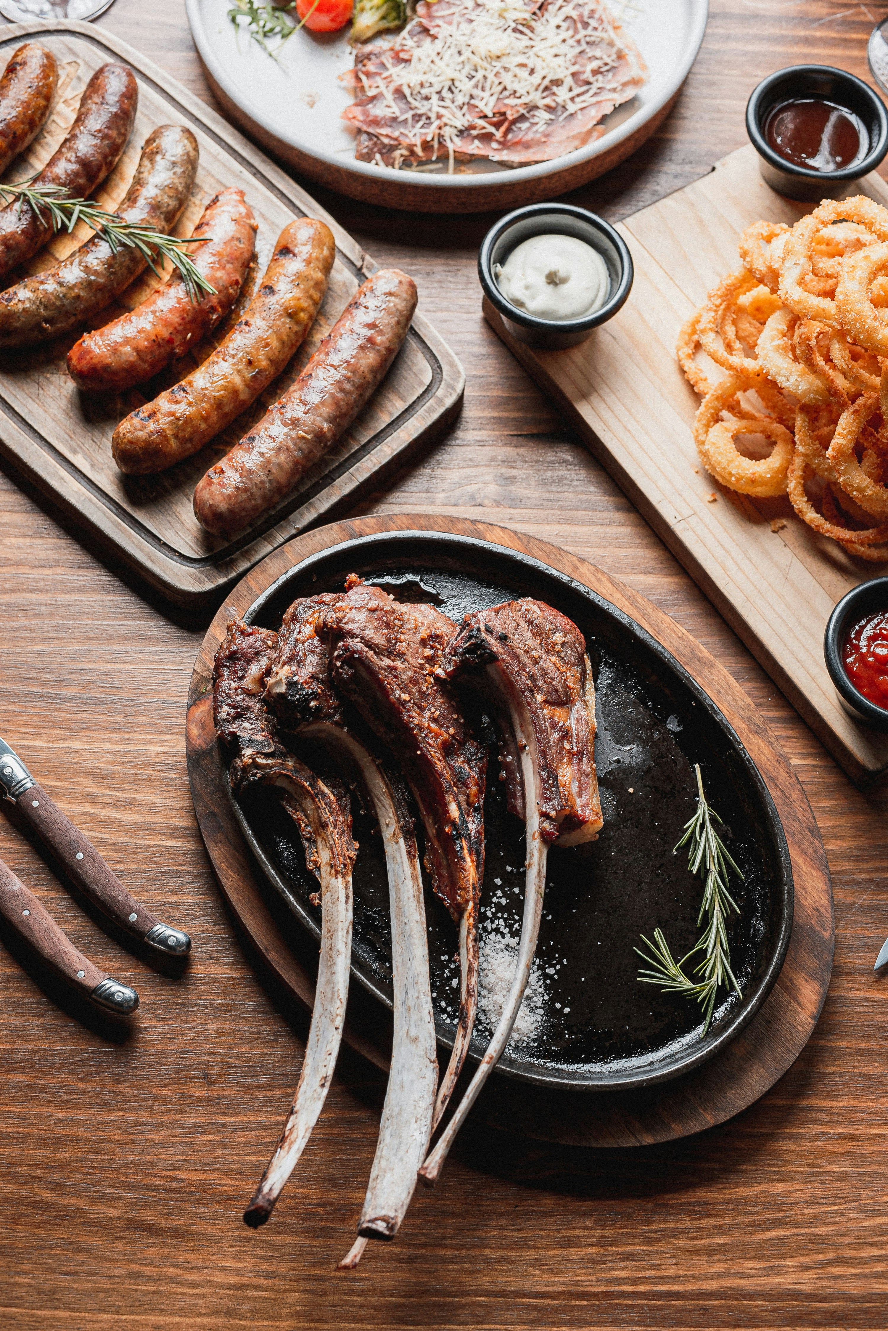 Center-cut Feast: A Rustic Spread of Grilled Meats and Crispy Onions