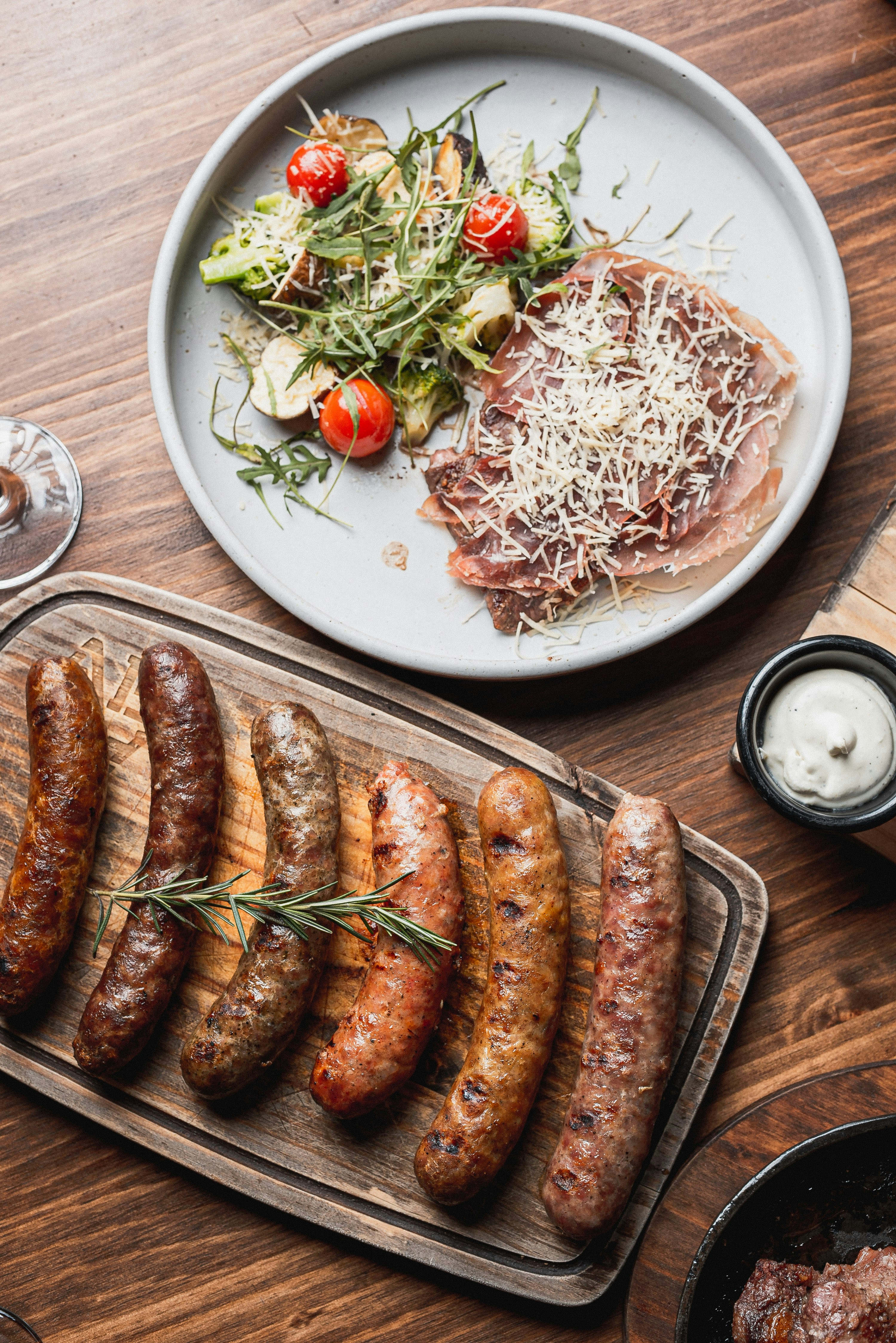 Charred Sausage Flight with Herb Salad and Parmesan-Studded Roast