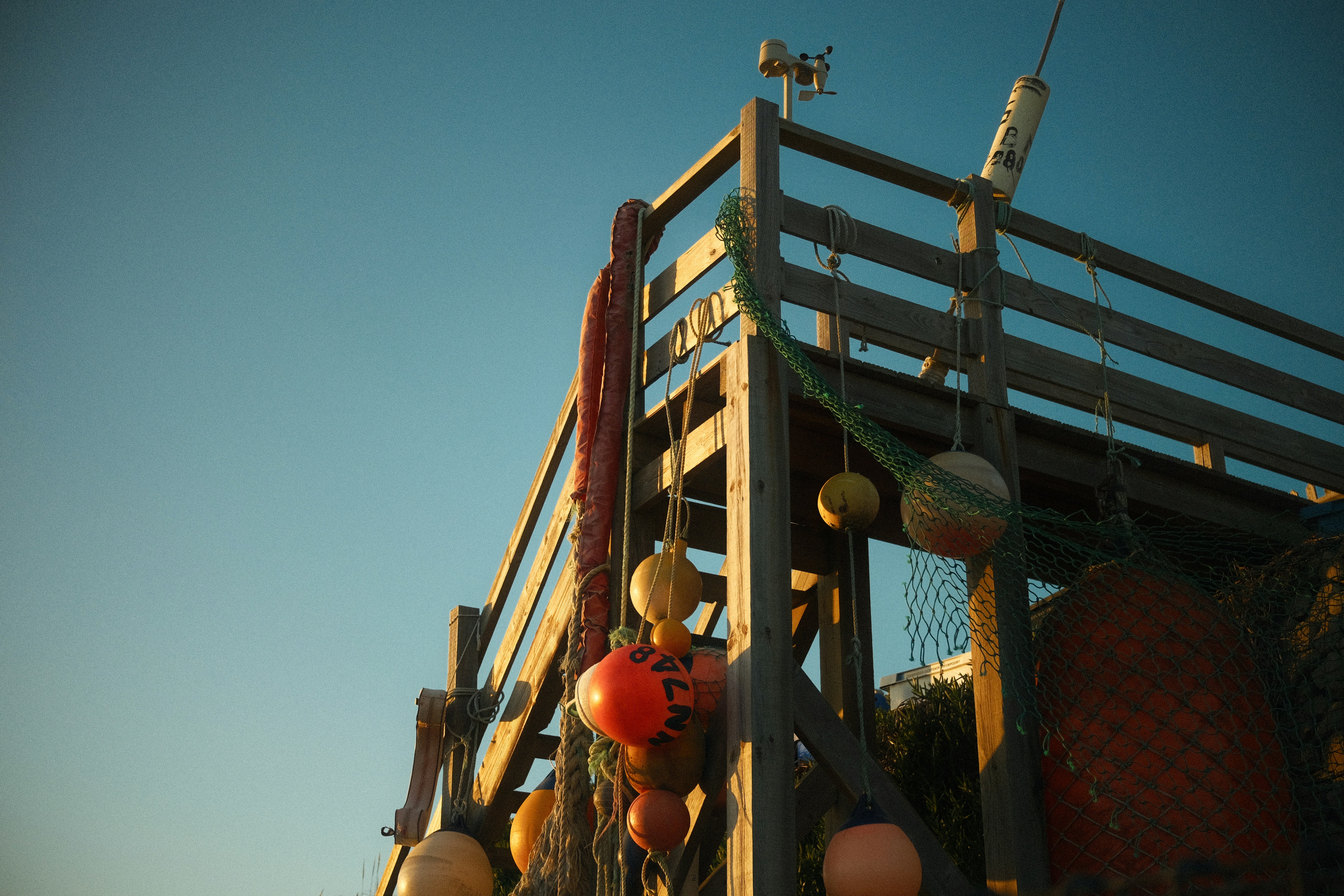 Amber Buoys and Wooden Ladder at Dusk Pier