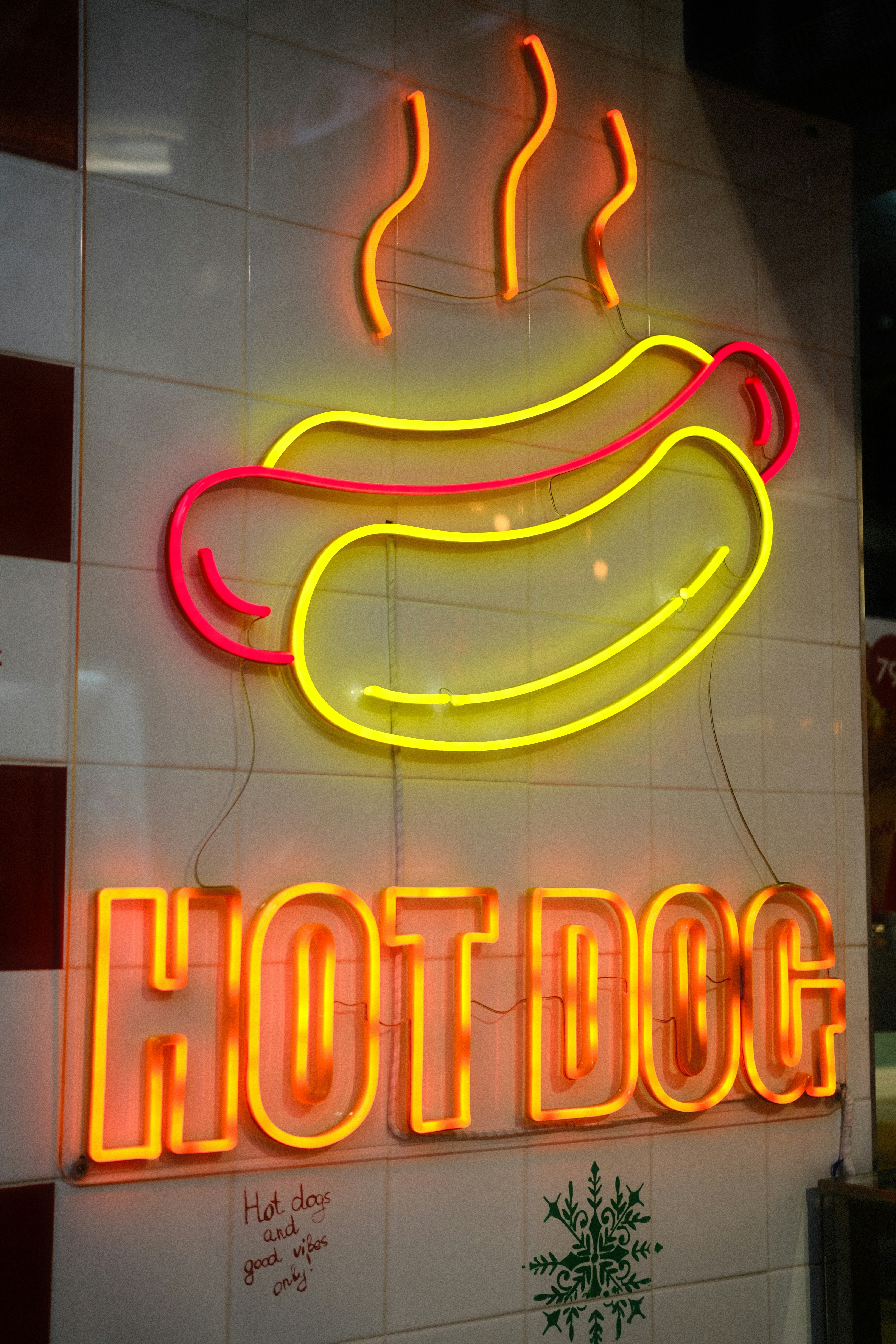 Neon Heat: Hot Dog Sign Illuminating a Night Fridge Front