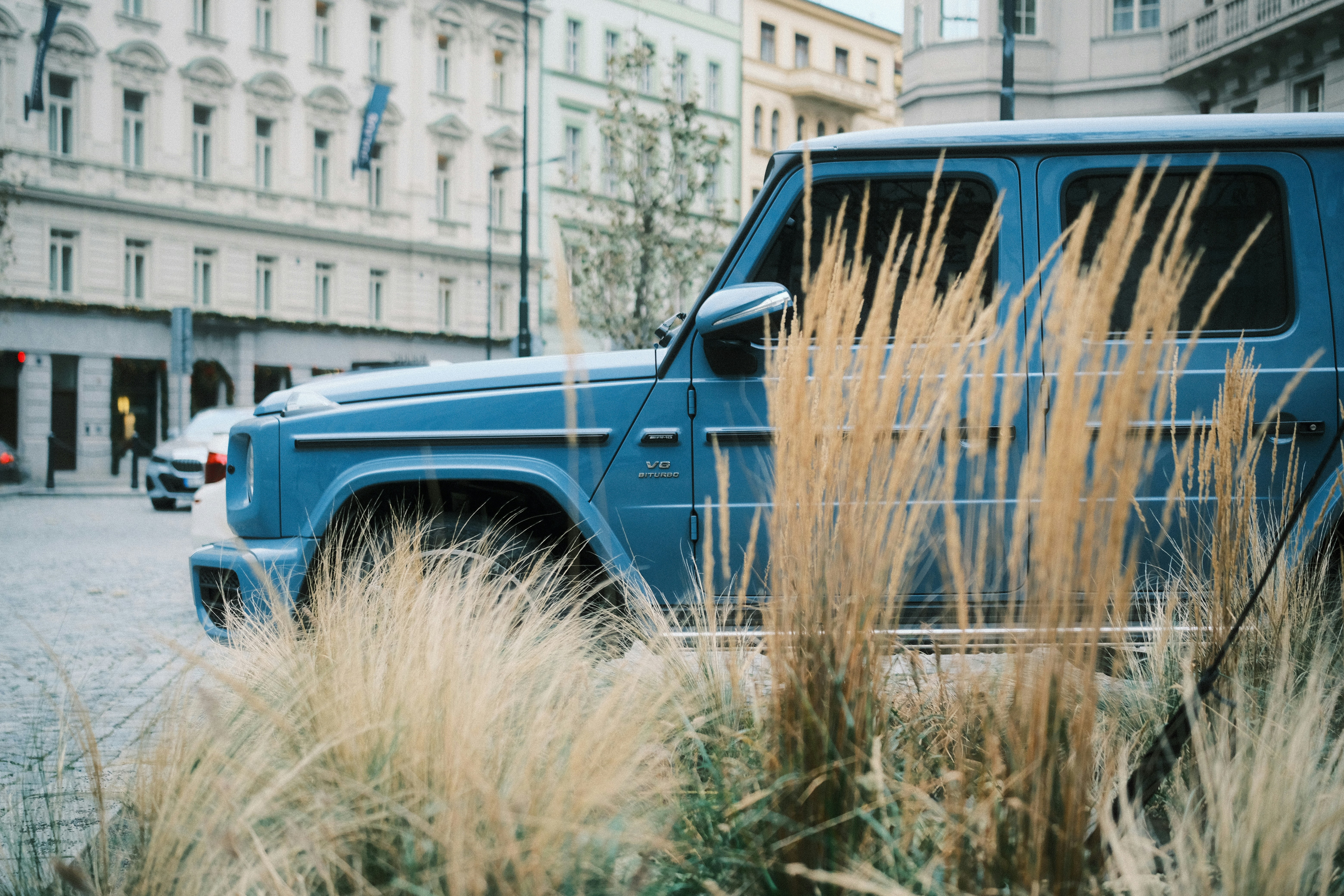 Midday Blue: A Classic Truck Among Urban Dunes