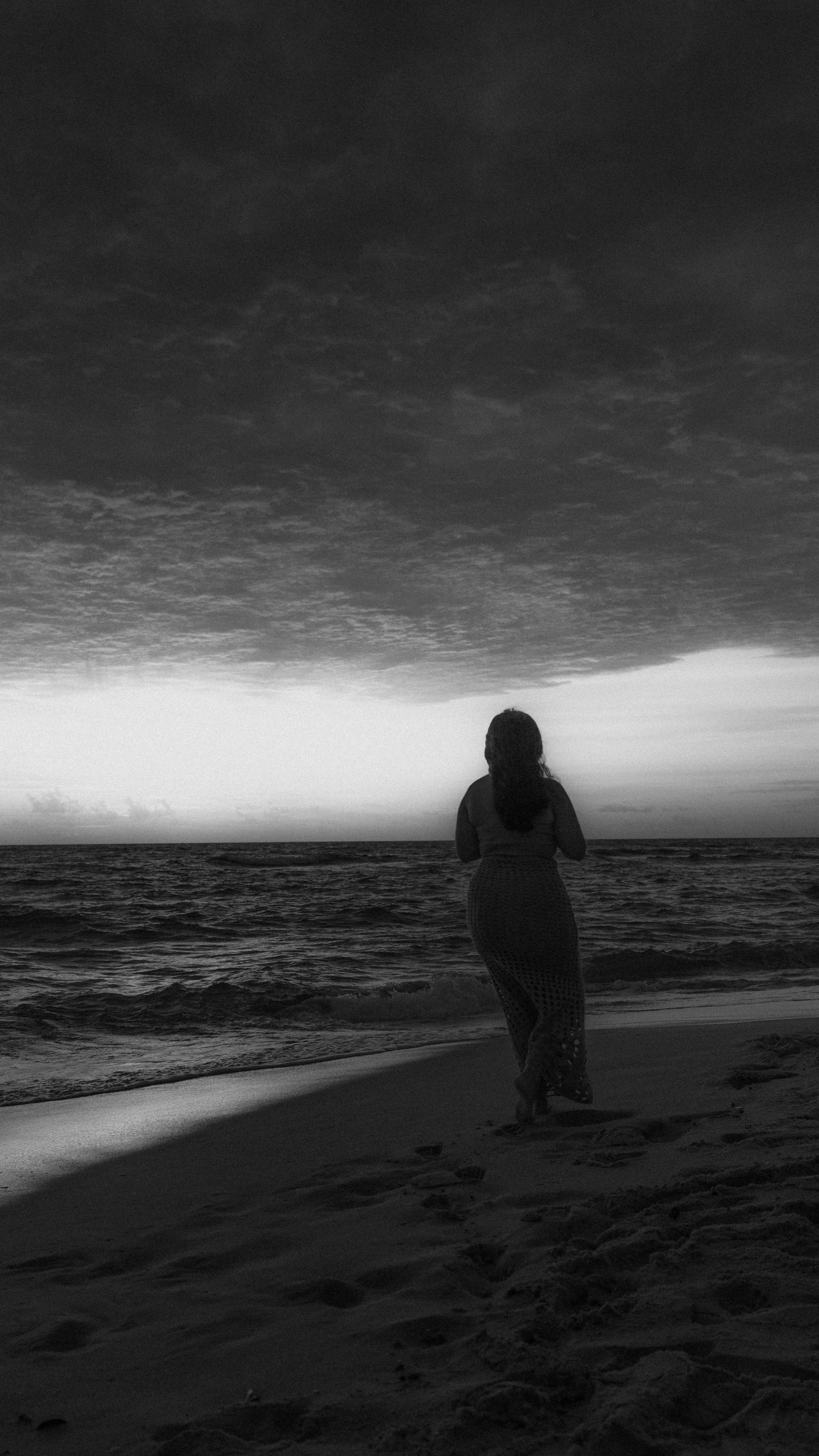 Silhouette Walk: A Quiet Moment on the Dusk Shore