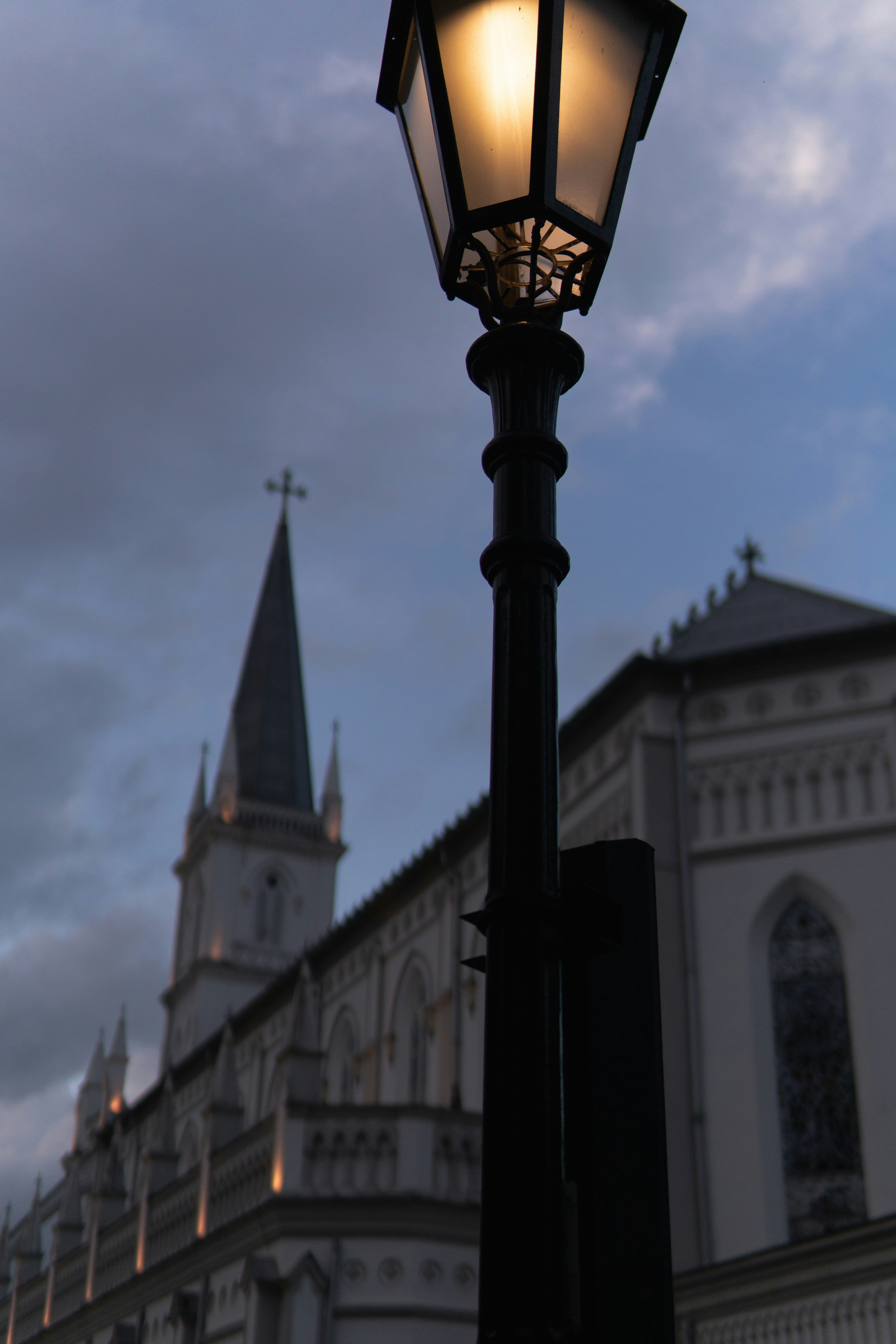 Gaslit Streetlamp Framing a Historic Facade at Dusk