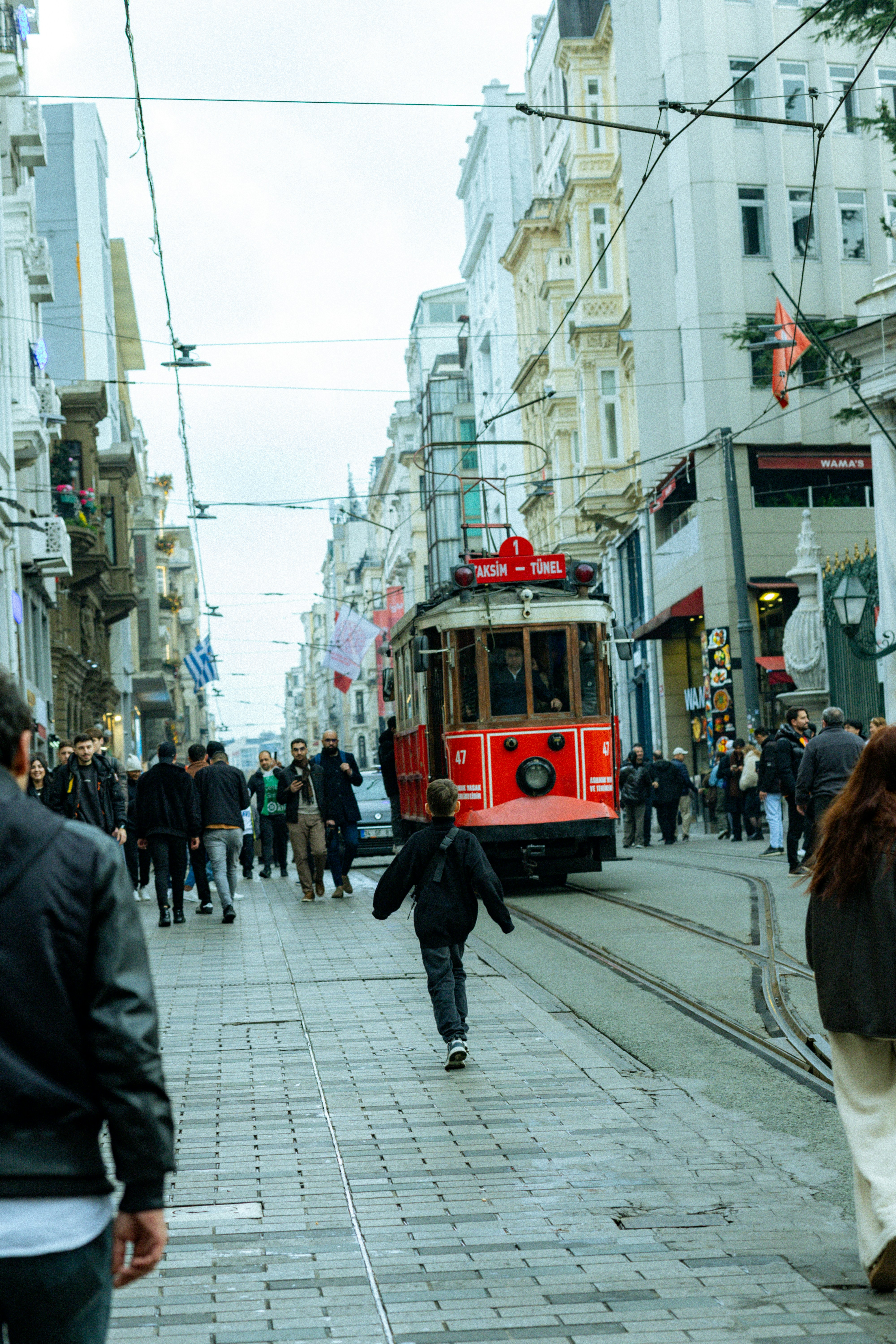 Electric Avenue: The Red Tram Breaks the Crowd