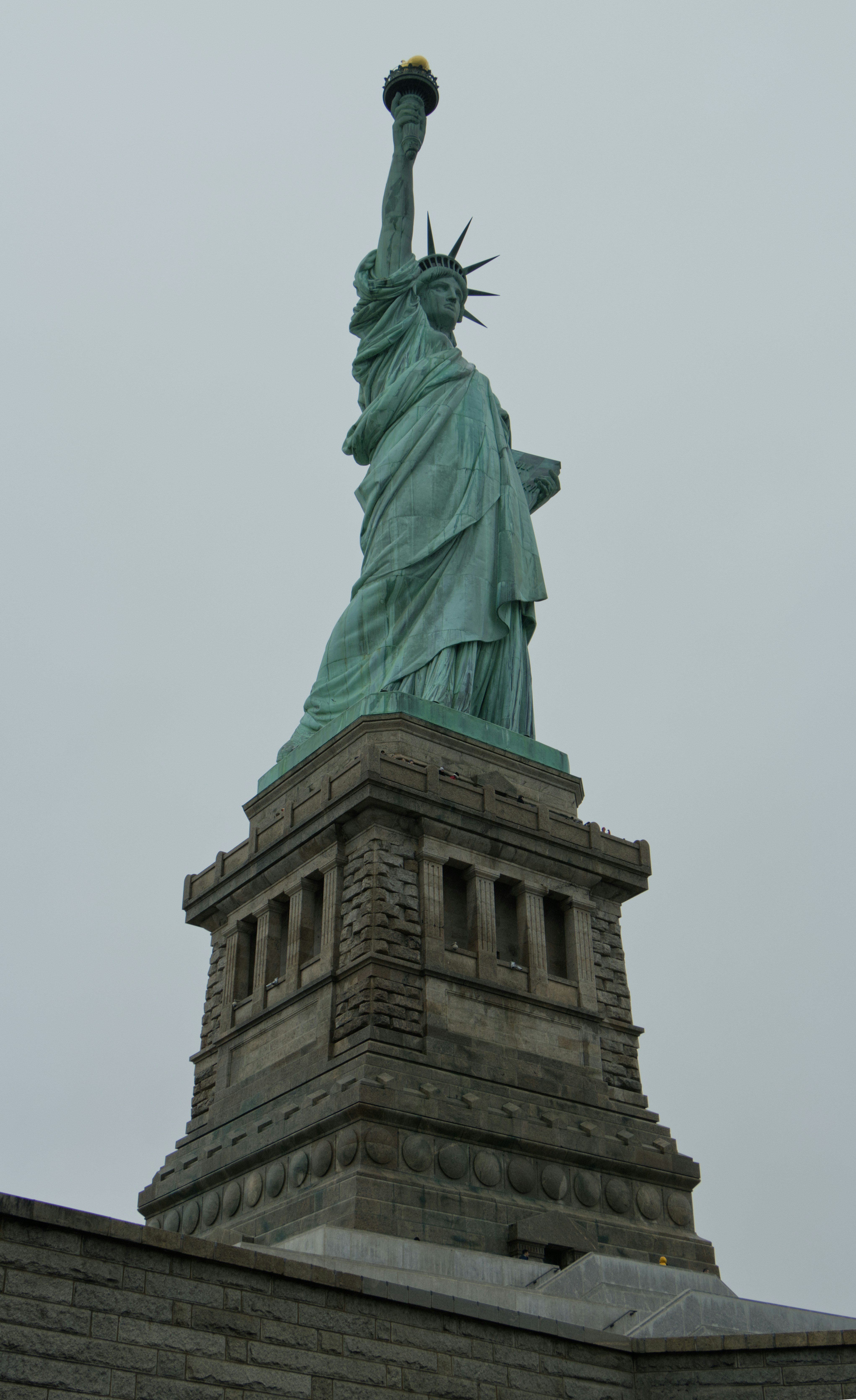 Statue of Liberty from a Grounded Perspective: Crowned Grandeur in Quiet Light