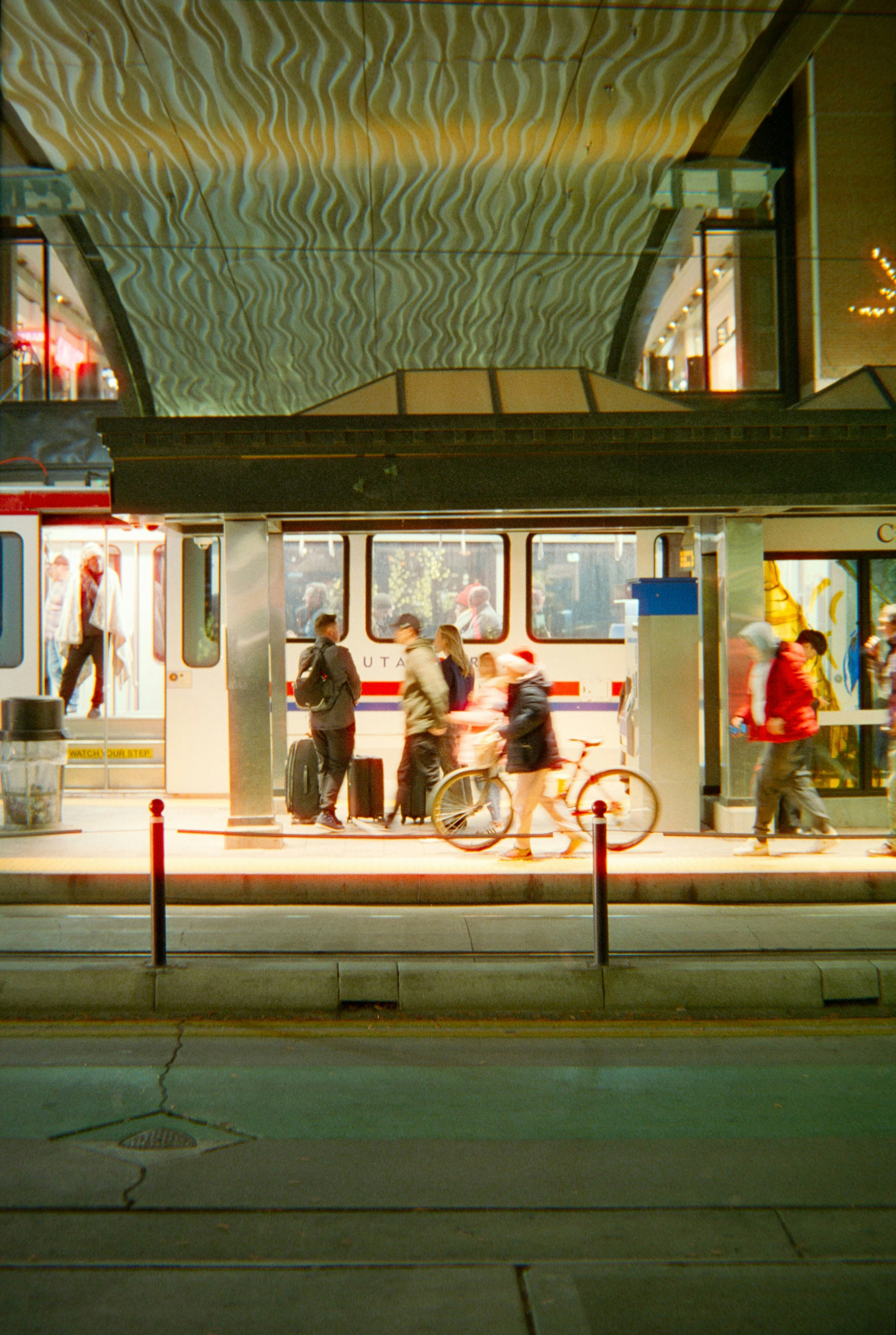 Night Platform Pulse: Riders and a Row of Glass Doors