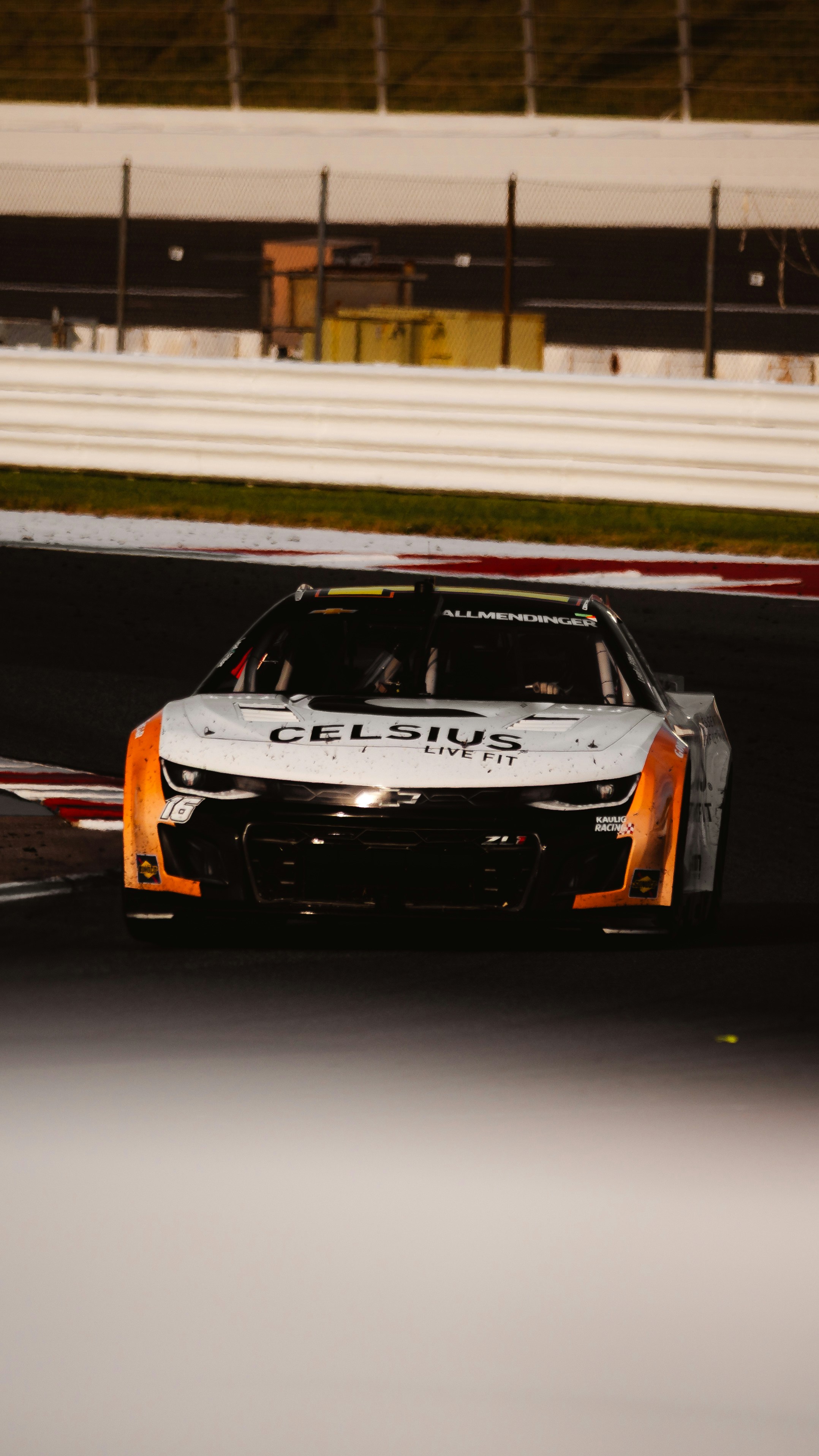 Celsius Racecar Bites the Apex on a Shadowed Track