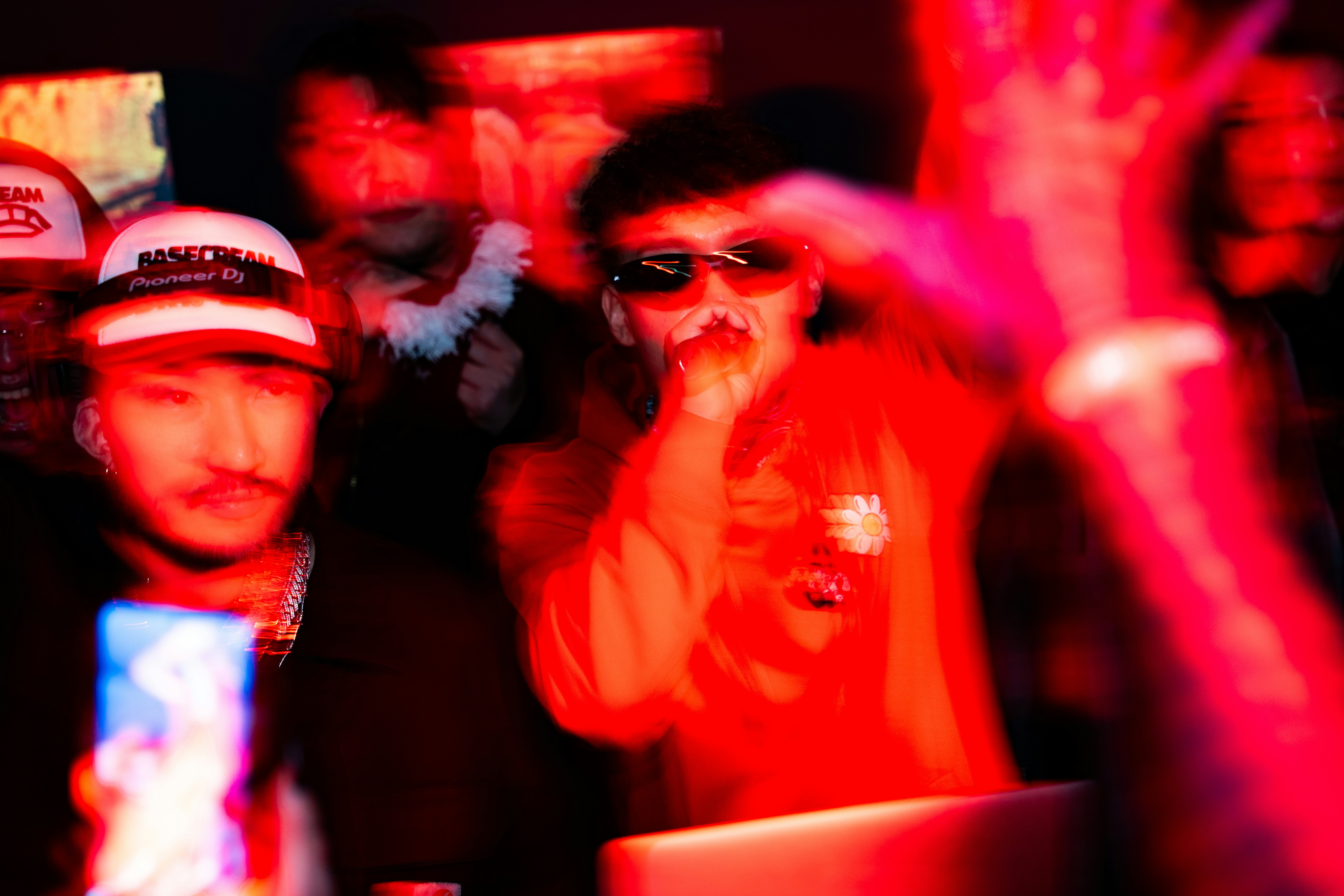 Midnight Groove: Blurred Faces in Red Light