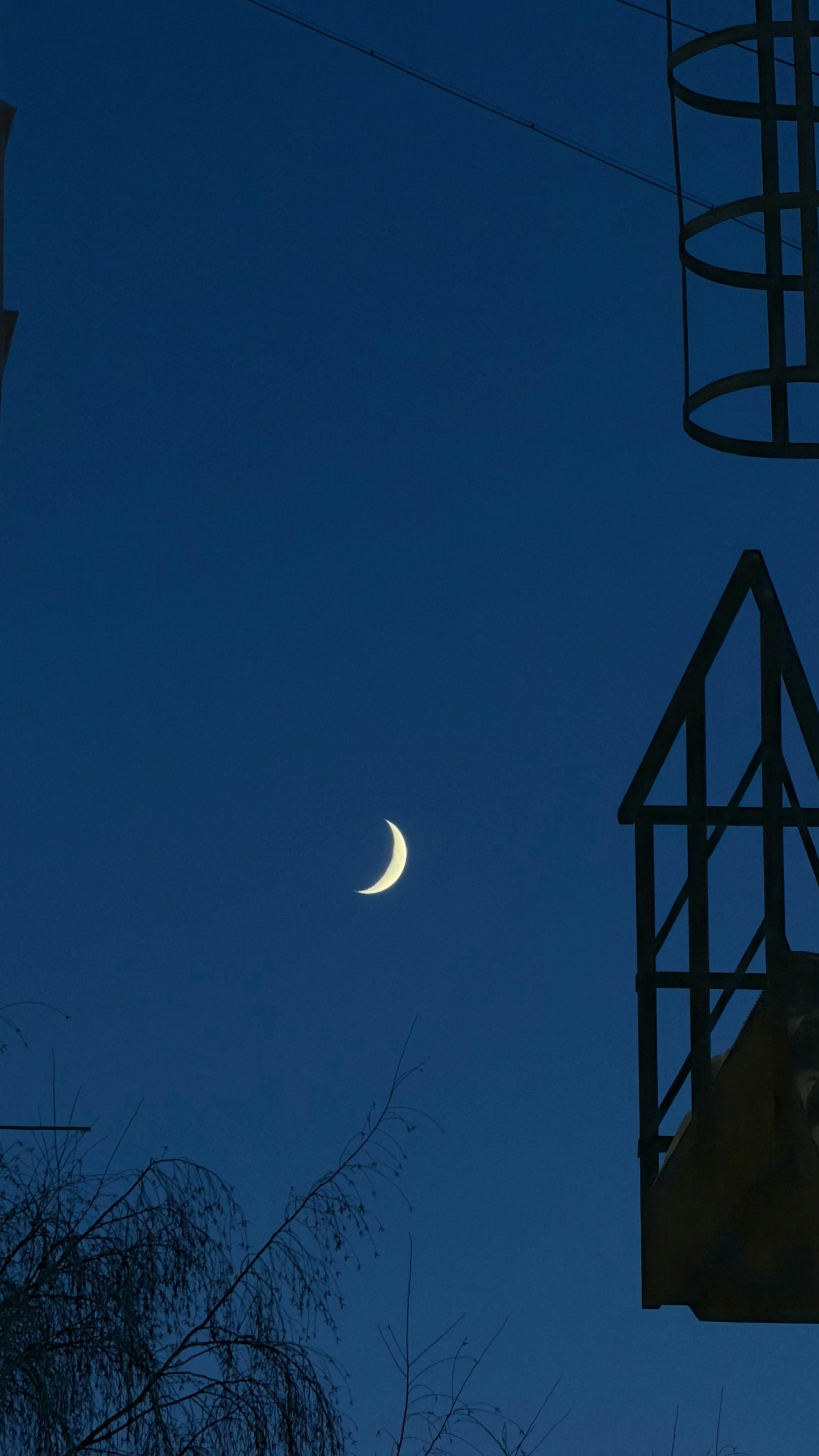 Crescent moon in the dark blue night sky.