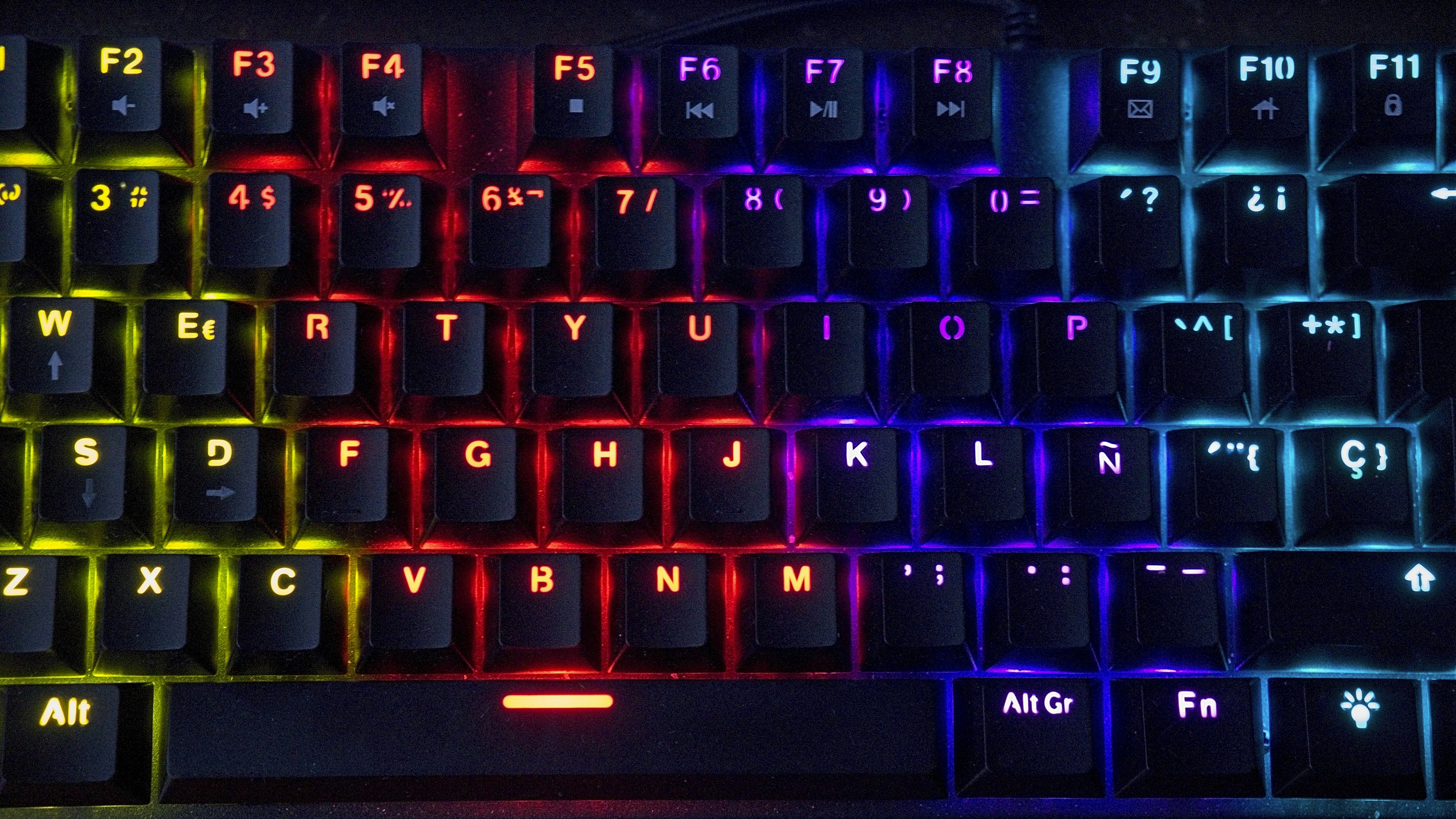Neon Keyboard Symphony: A Rainbow of Keys Illuminated in Low Light