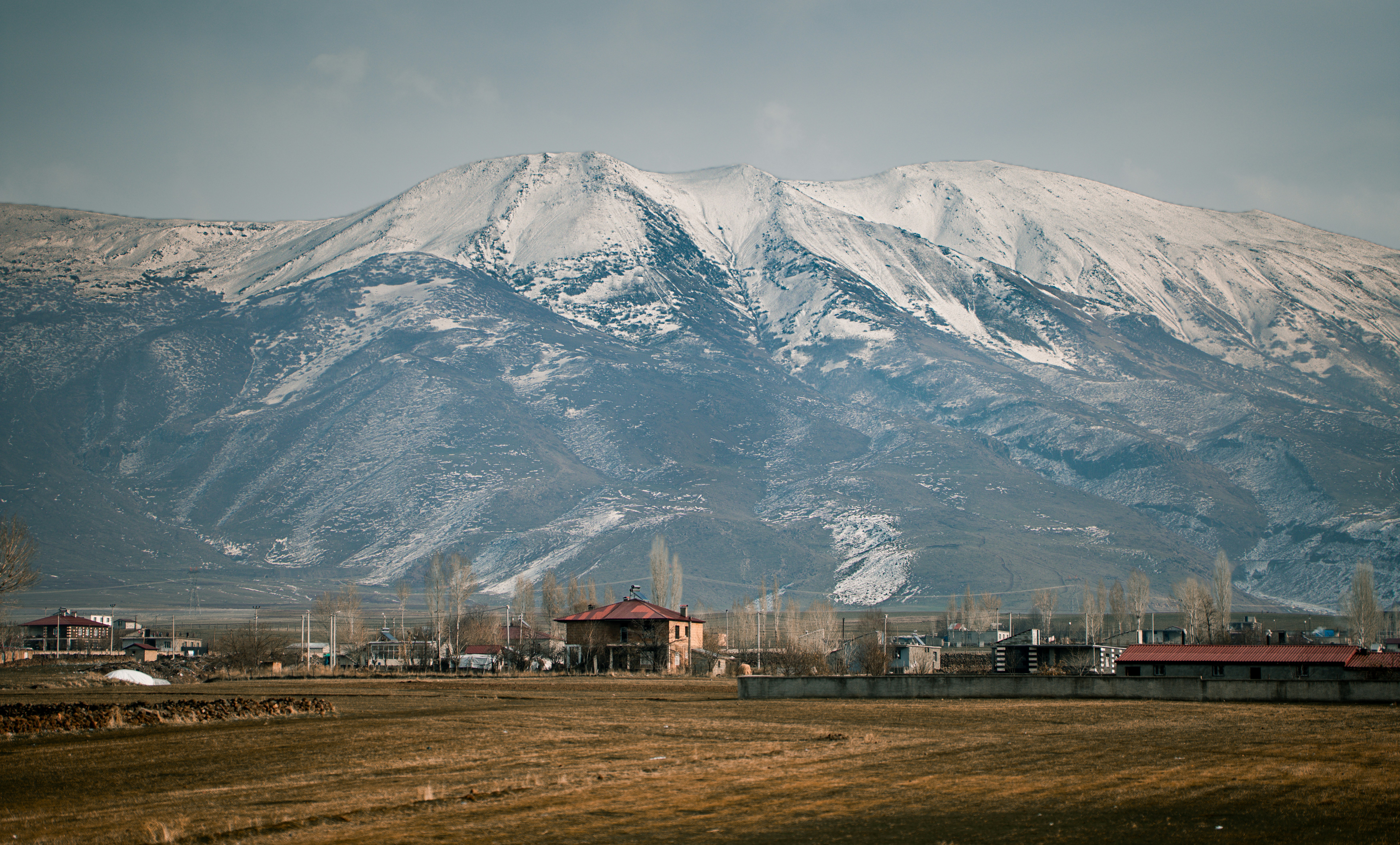 Snow-kissed Peaks Over a Quiet Valley Town