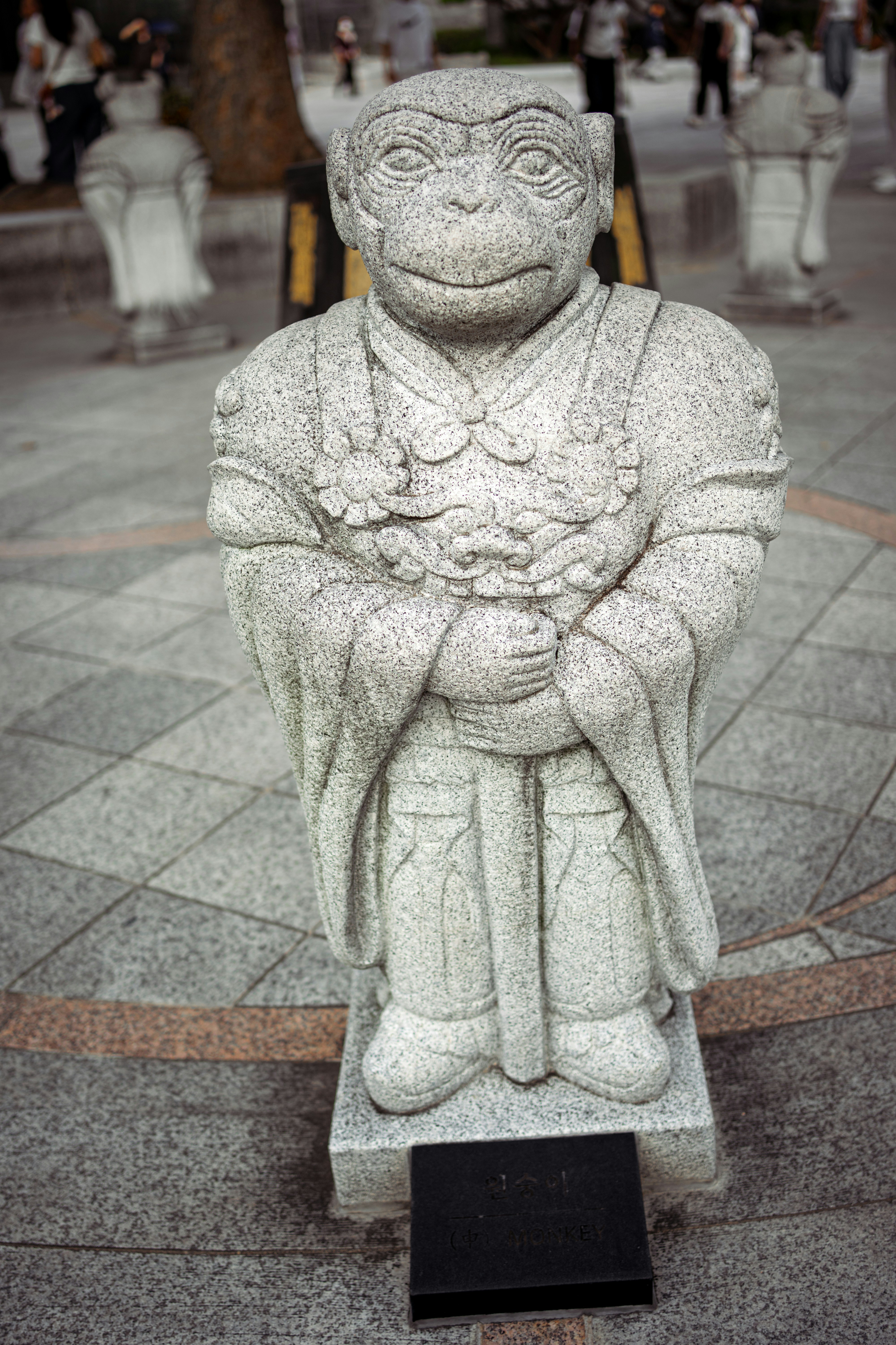 Stone Wisecrack: A Stony Monk Guarding the Plaza