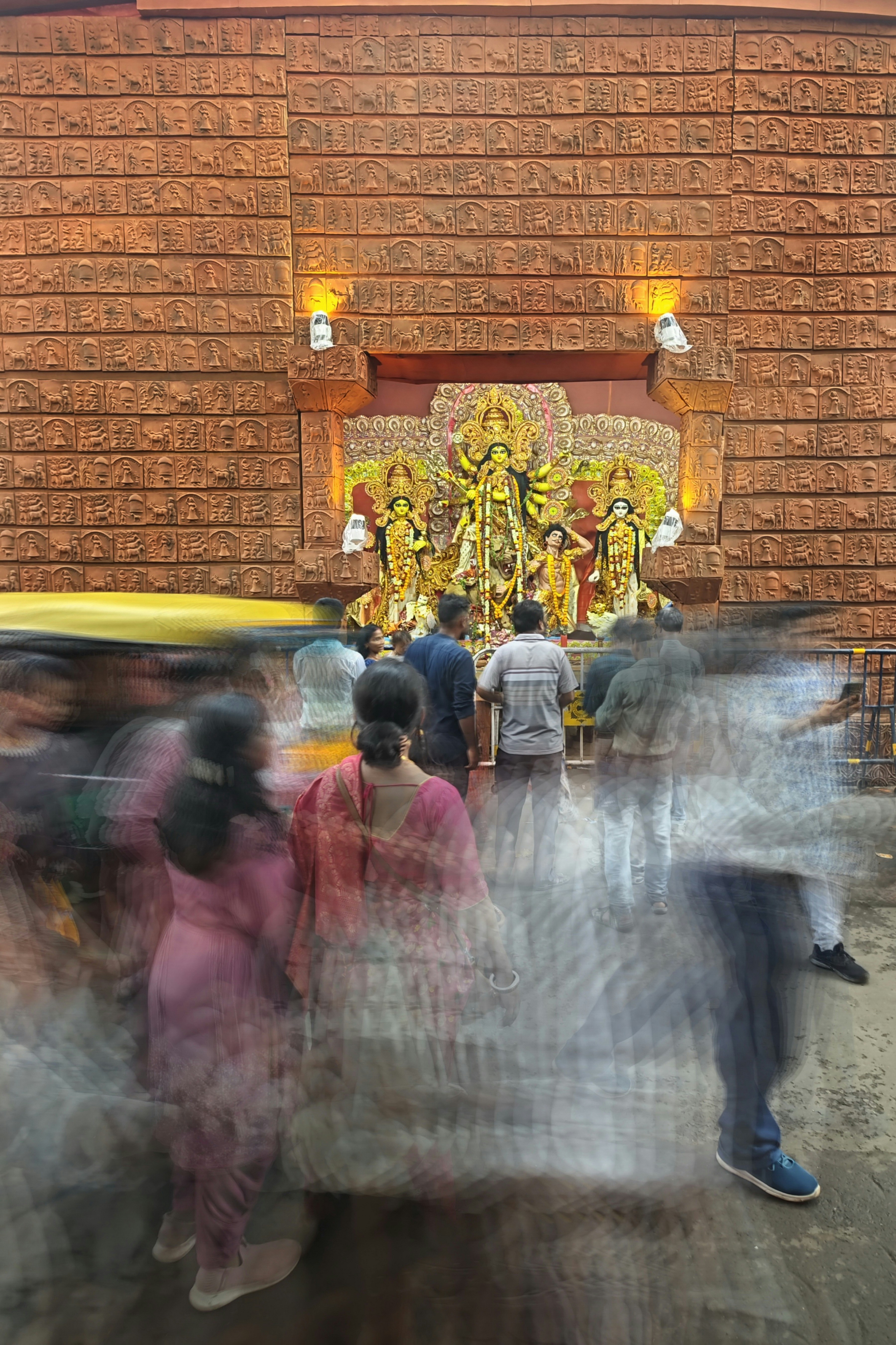 People praying before a hindu deity statue