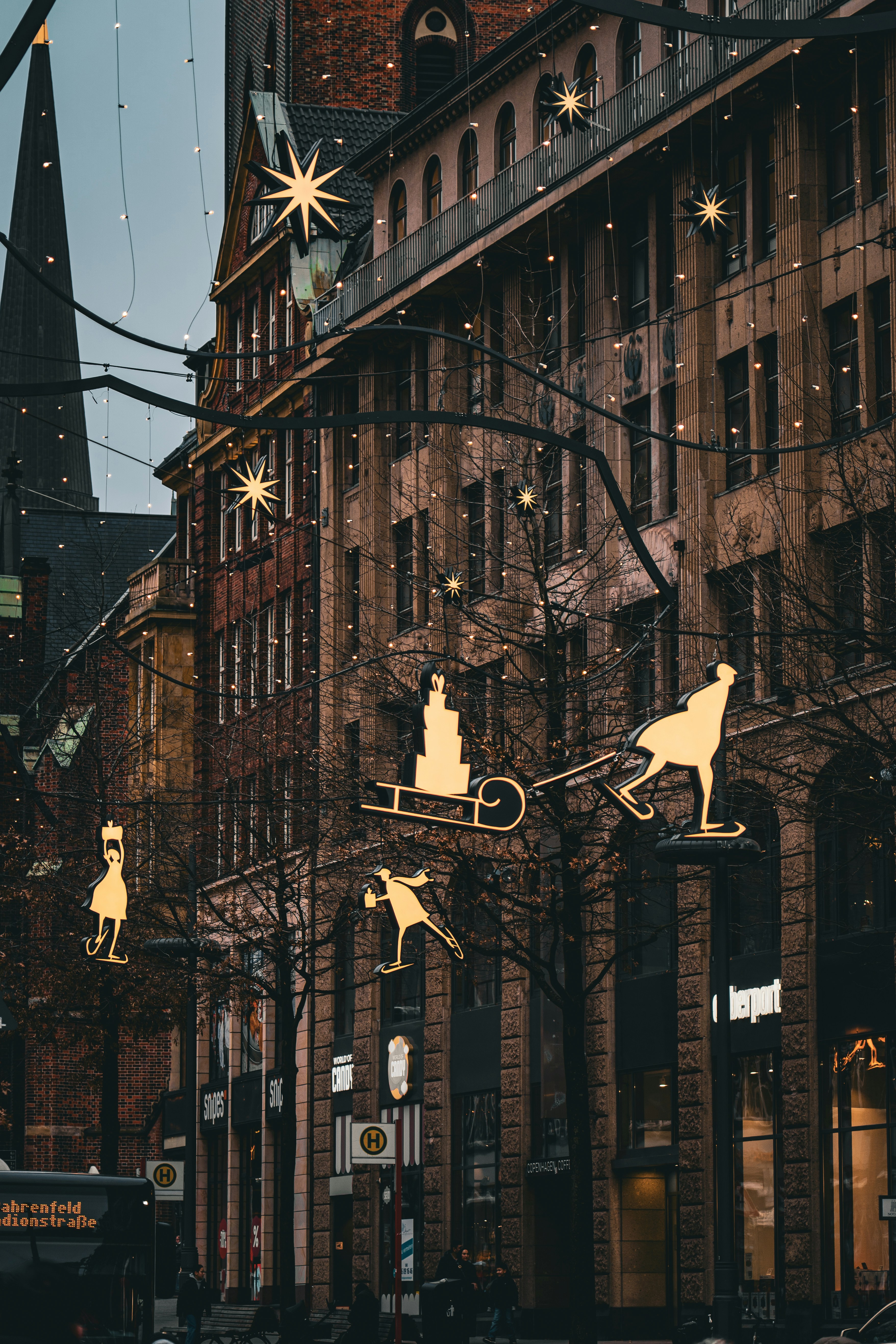Festive silhouettes: golden icons glow against a historic street