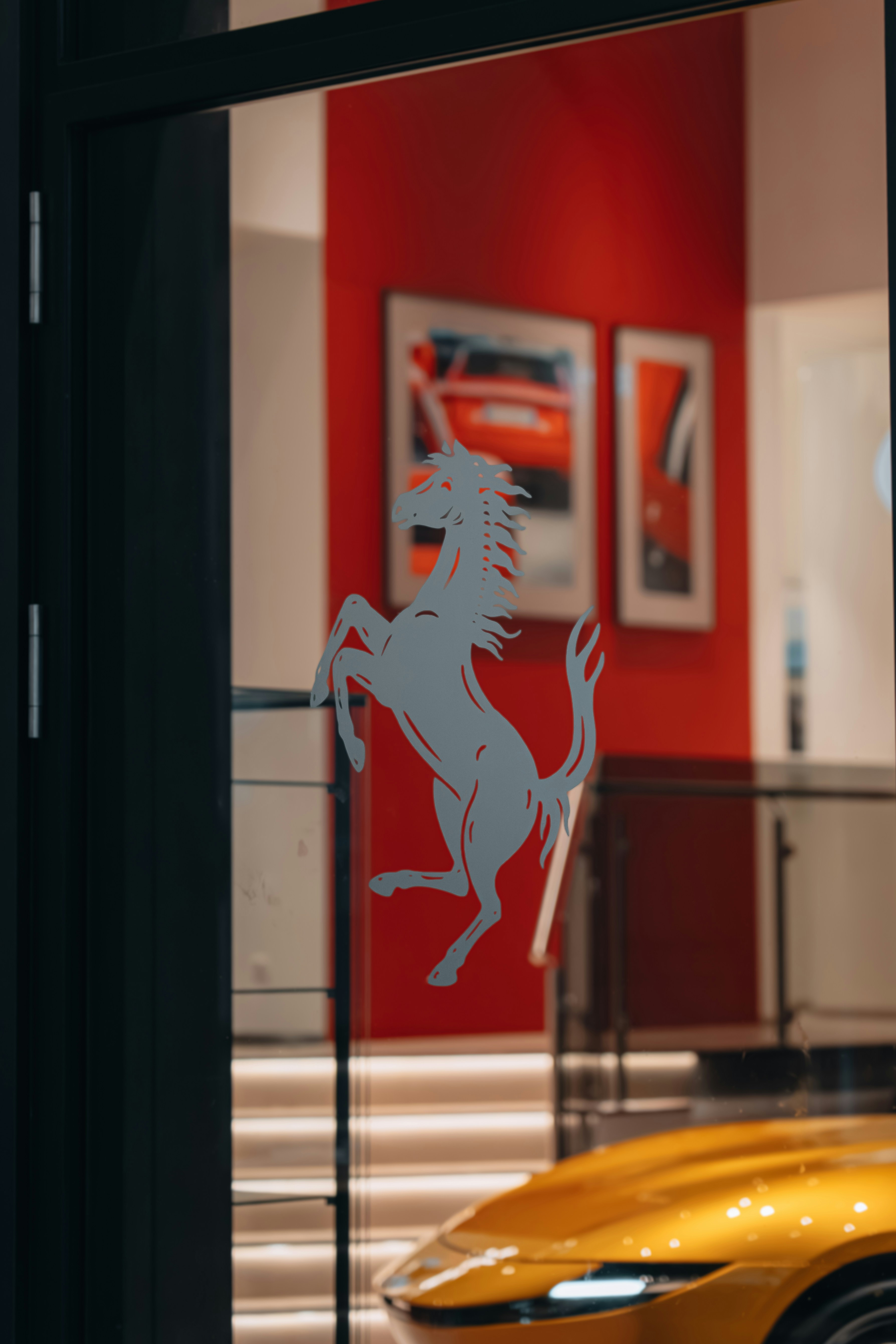 White Stallion Silhouettes on Glass in a Red-Accented Lobby