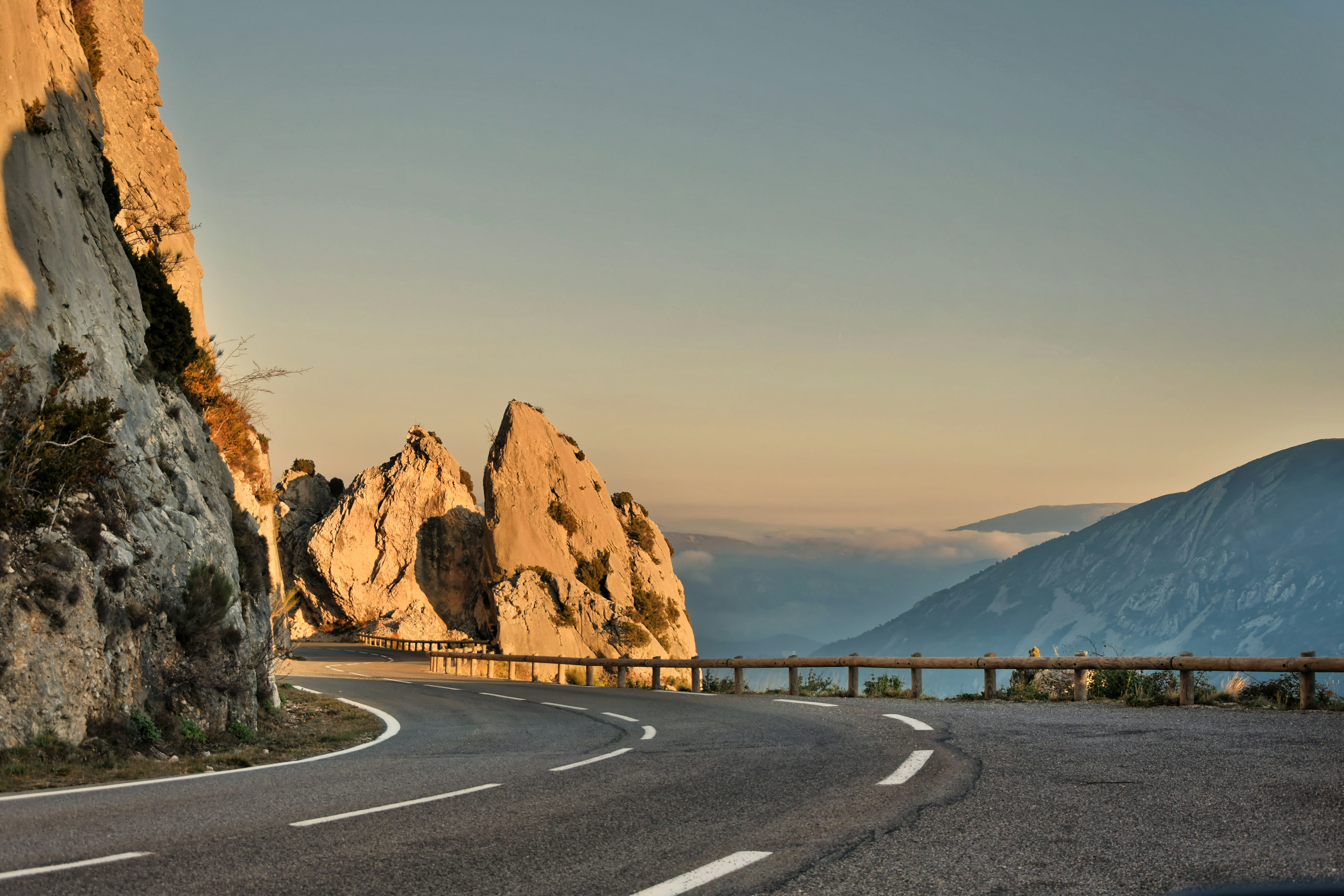 Sunlit Curves: A Mountain Road Bordered by Golden Cliff
