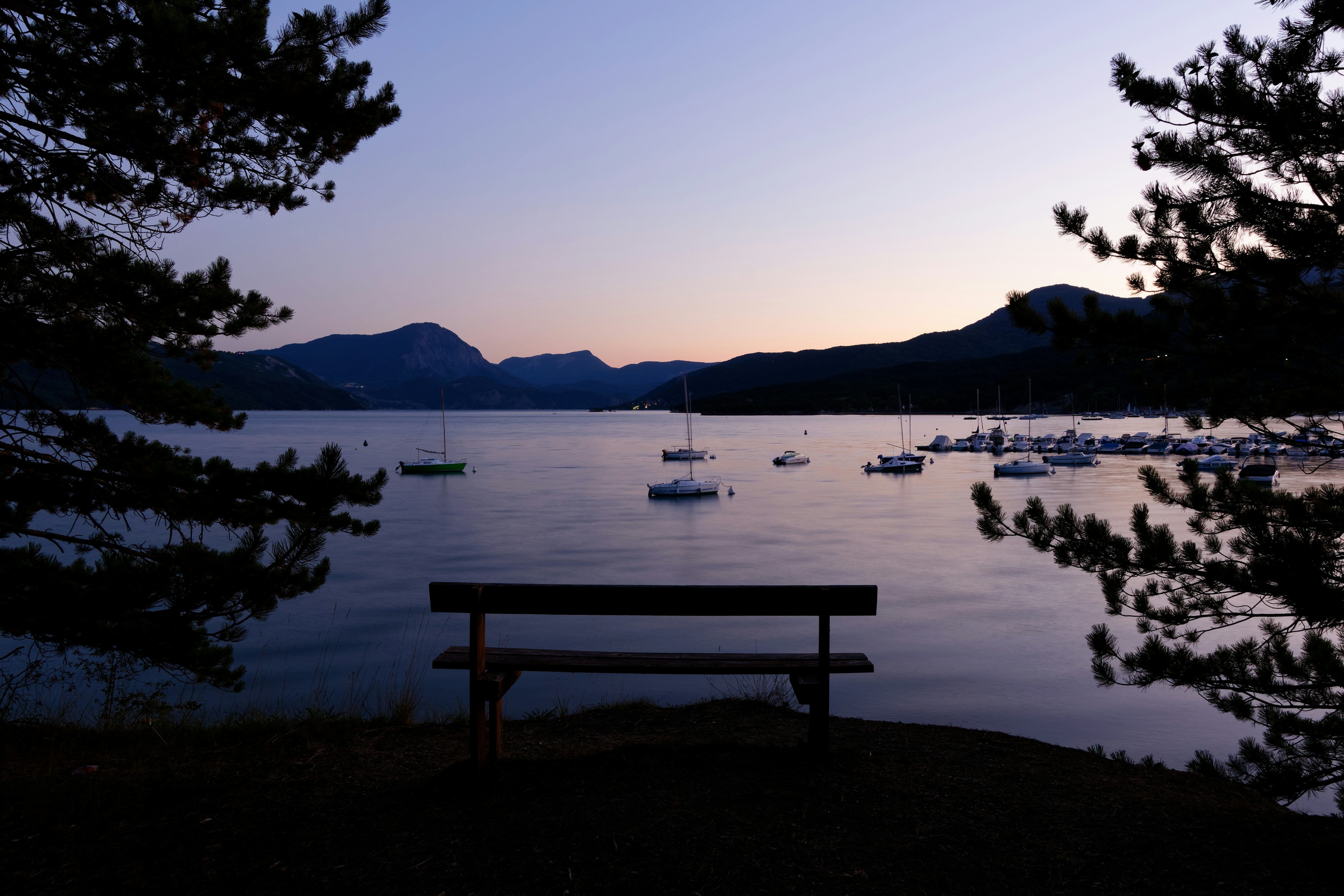 Dusk by the Pier: A Quiet Bench Watching Boats at Sunset