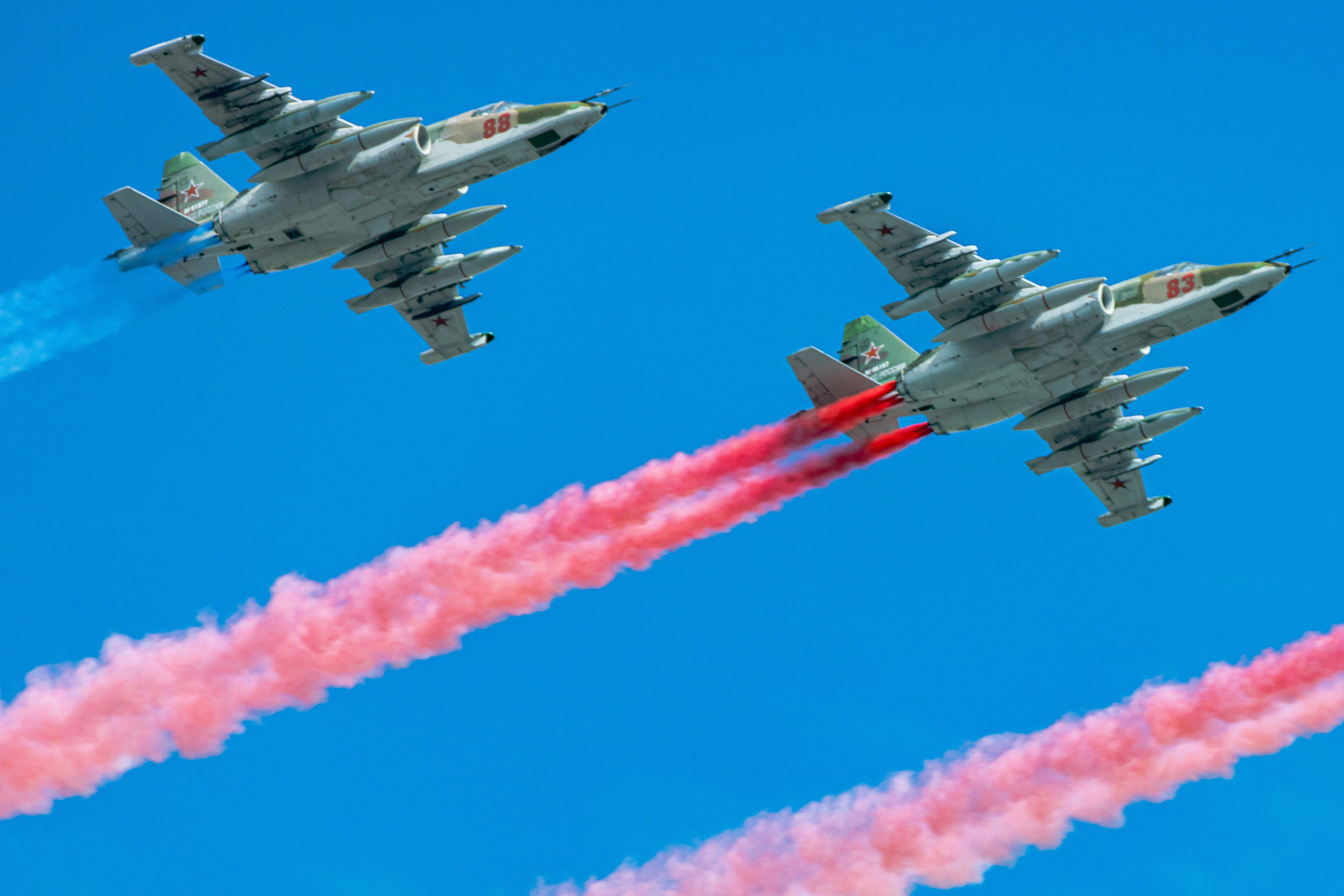 Twin Jet Show: Red Trails Across a Crisp Blue Sky