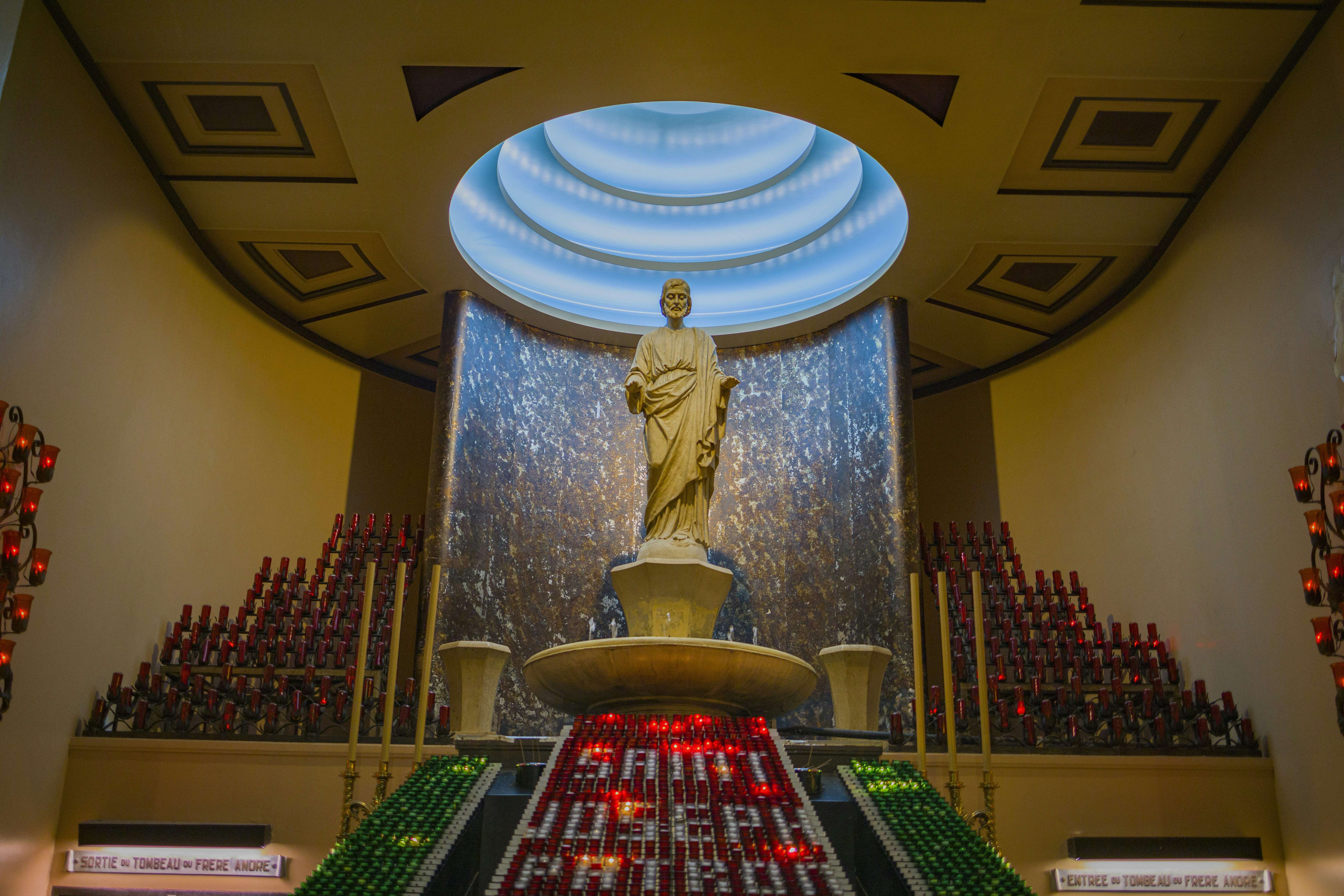 Statue Centered Under a Cascading Waterfall of Light