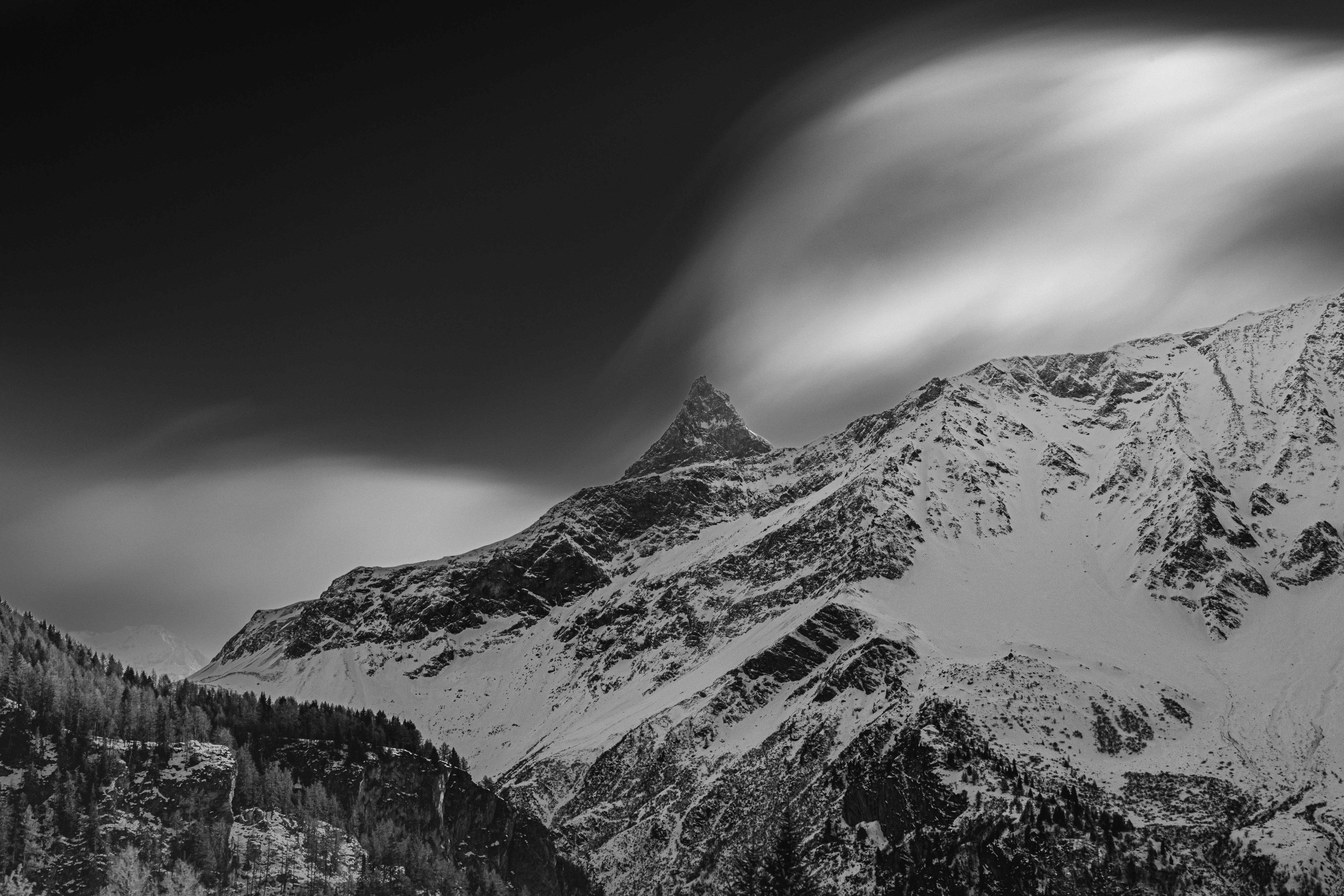 Peak Veil: A Snowbound Summit under a Moving Cloud