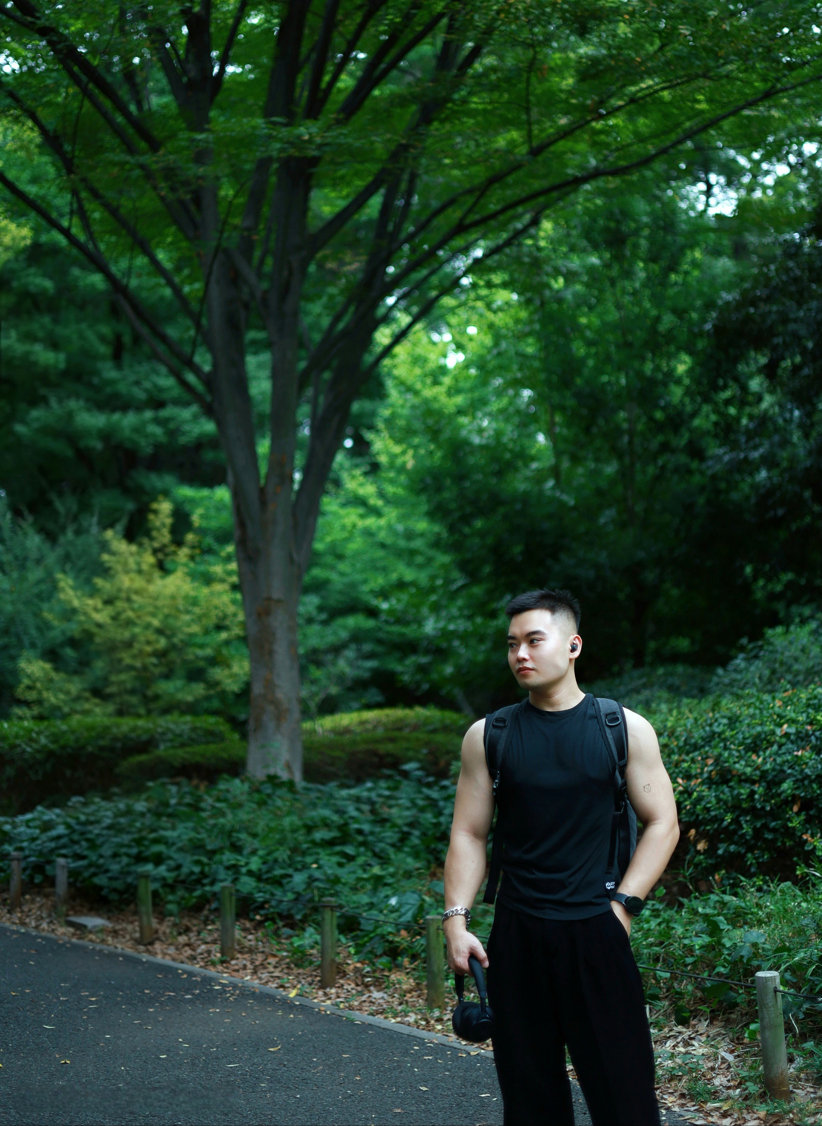 Athlete in the Park: Contained Confidence Against Green Backdrop