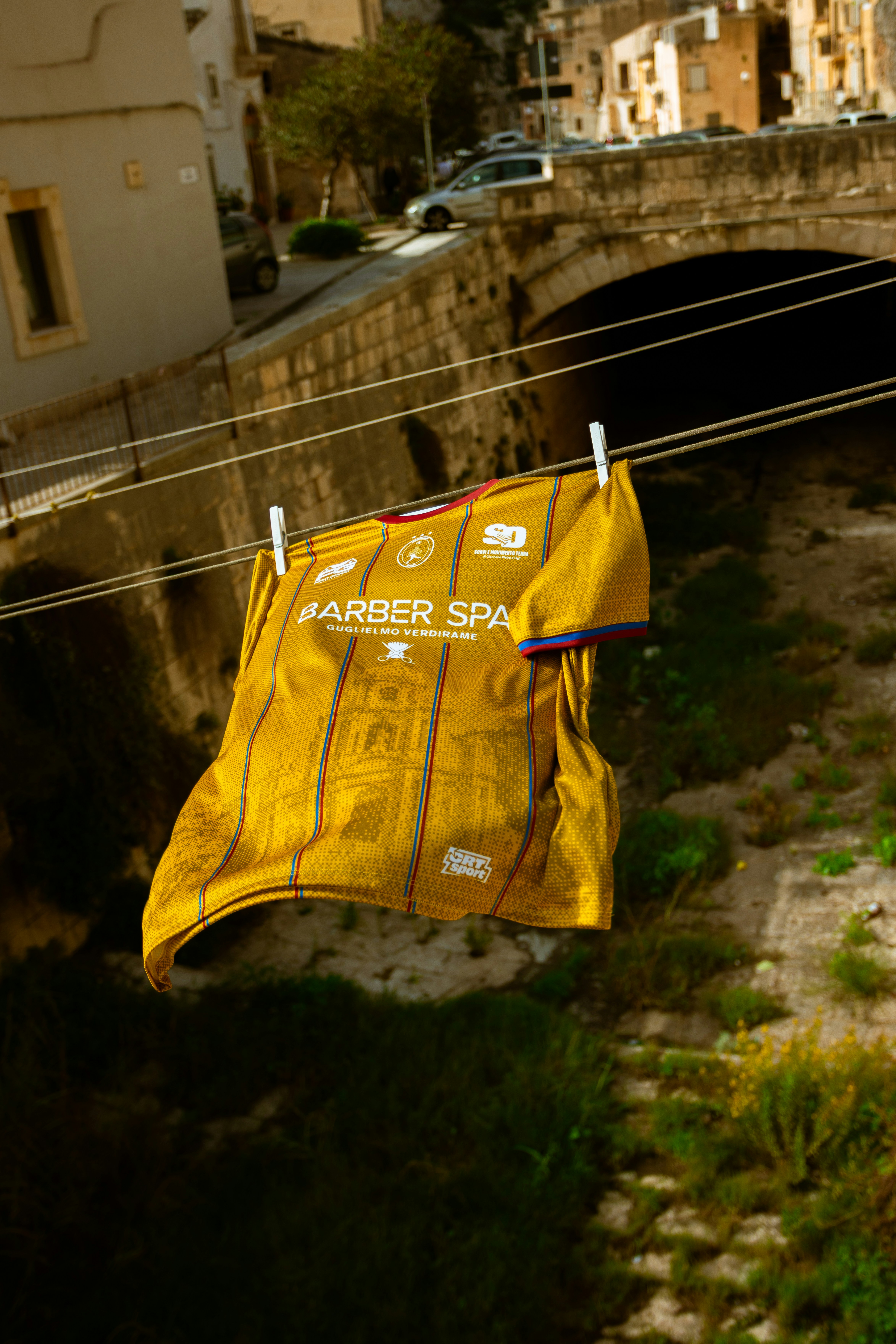 Laundry on a Line: A Sunlit Yard Scene with a Yellow Cloth Whispering in the Breeze