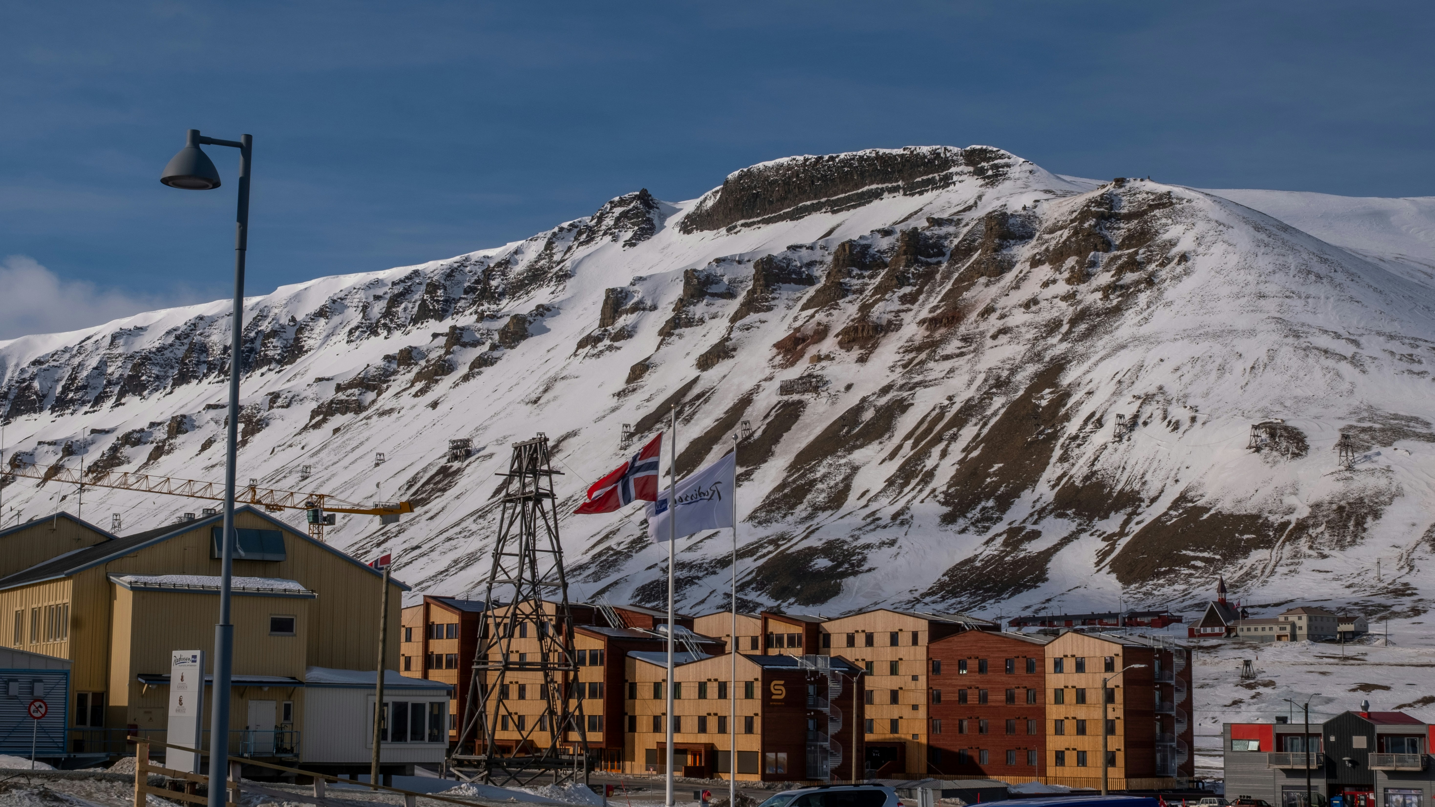 Snow-Capped Ridge Over a Norwegian Harbor Village