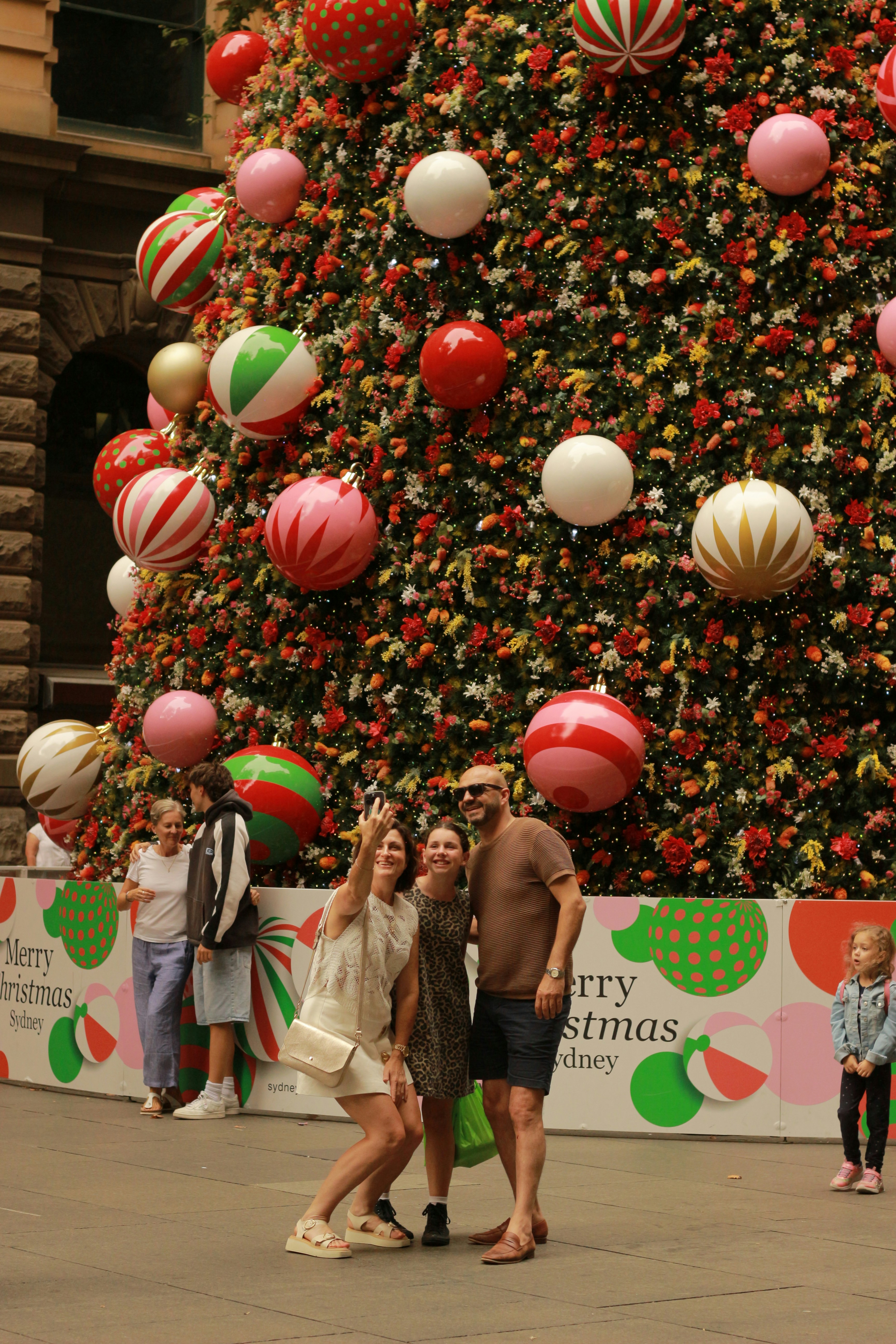 Joyful Pose under a Festive Christmas Tree