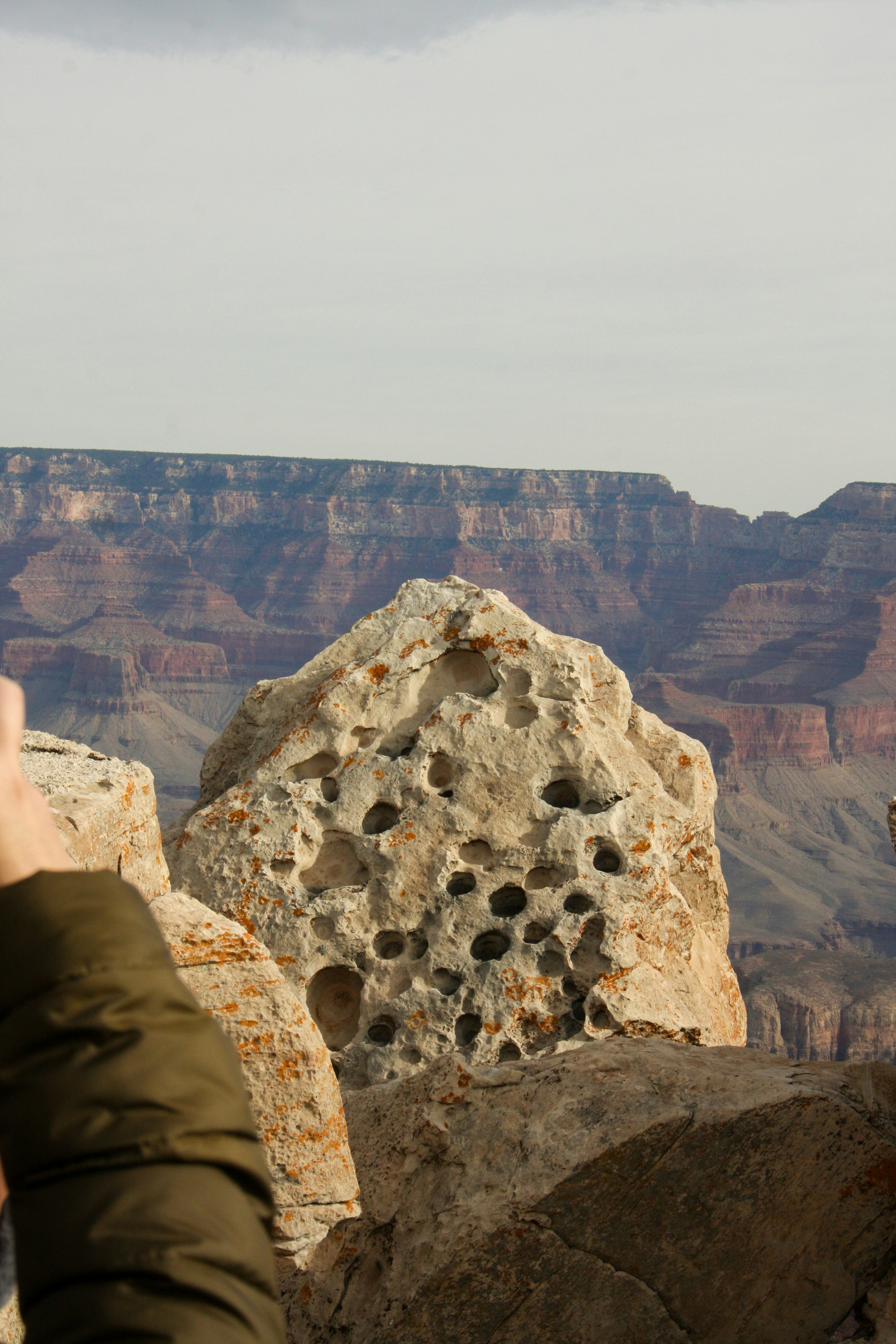 Stone sentinels at the edge: a hiker's view across the canyon