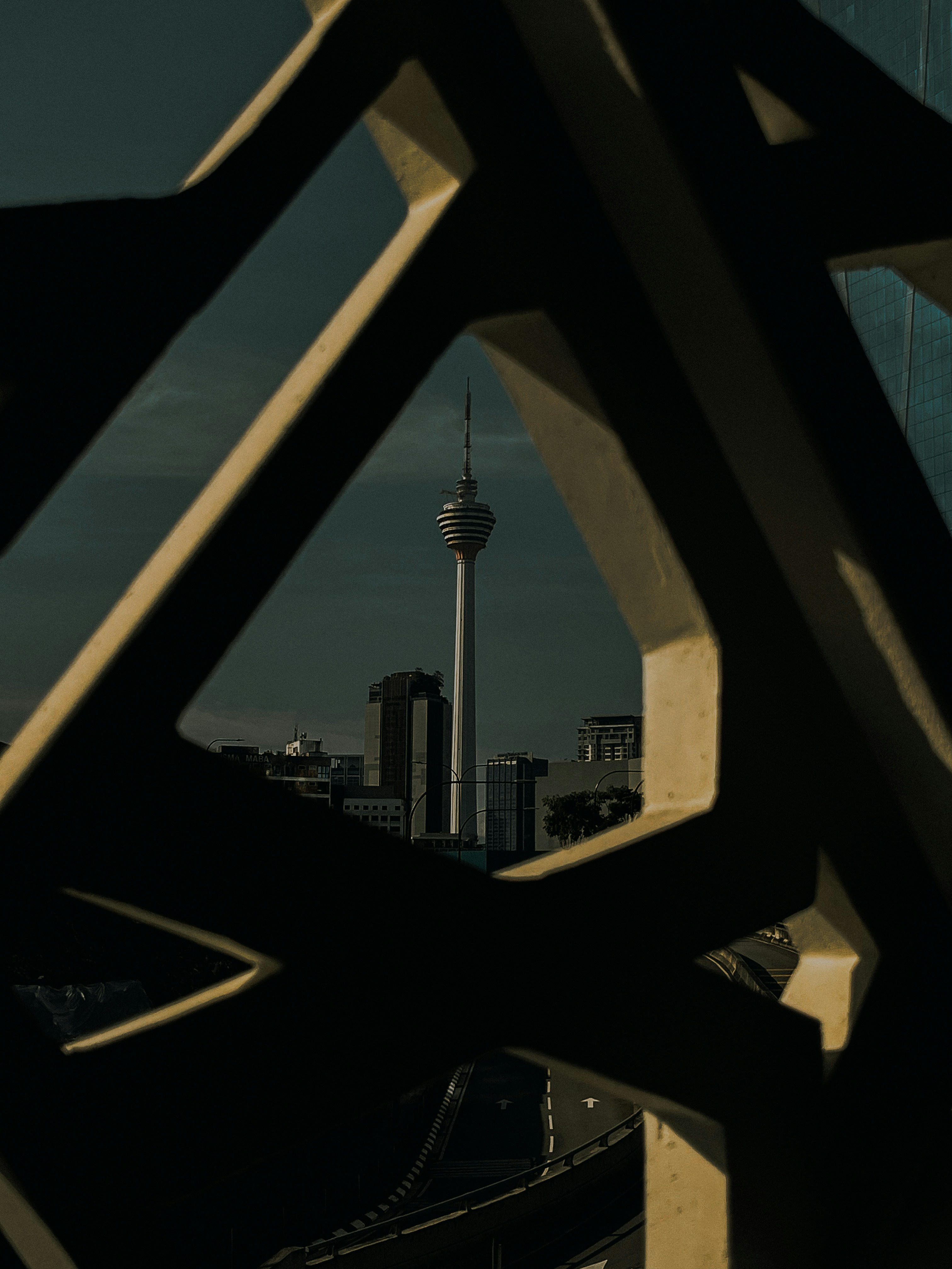 Through the Framed Gaps: City Tower Rising Between Concrete Arches