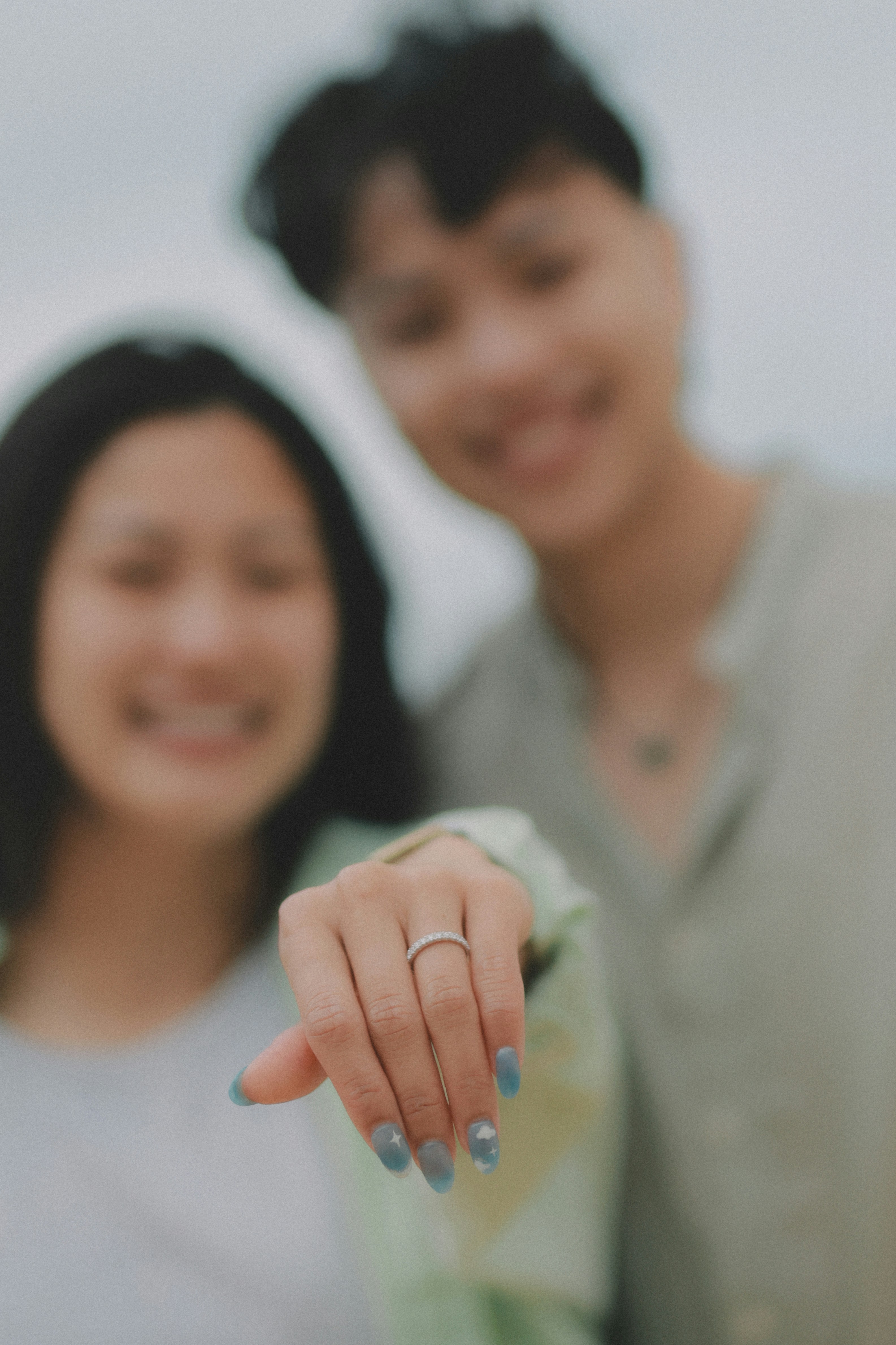 Blurred Joy: The Couple’s Ring in Soft Focus Moment