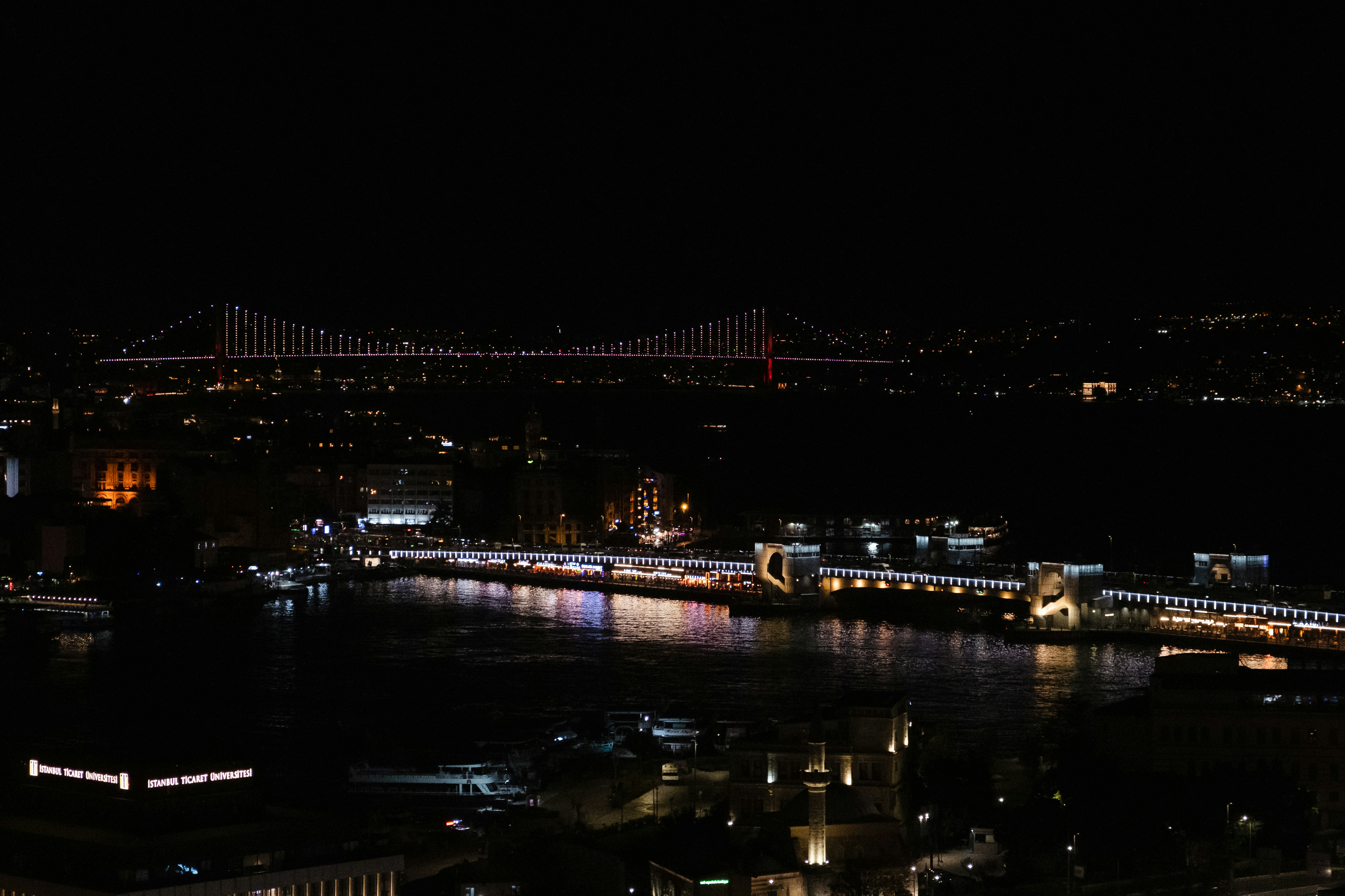 Nighttime Riverside: Illuminated Bridge and Waterfront