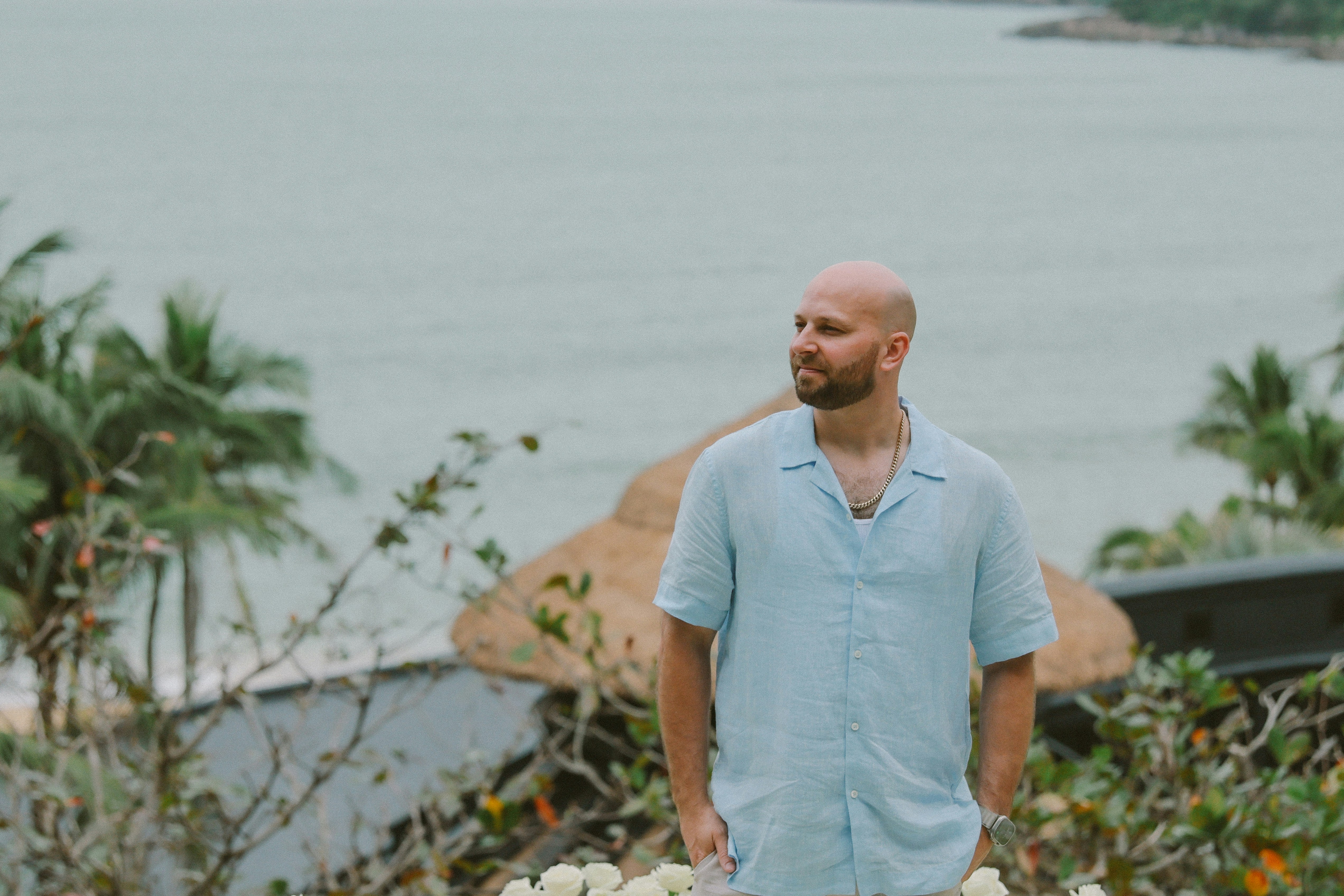 Lone portrait on a sunlit terrace with sea backdrop