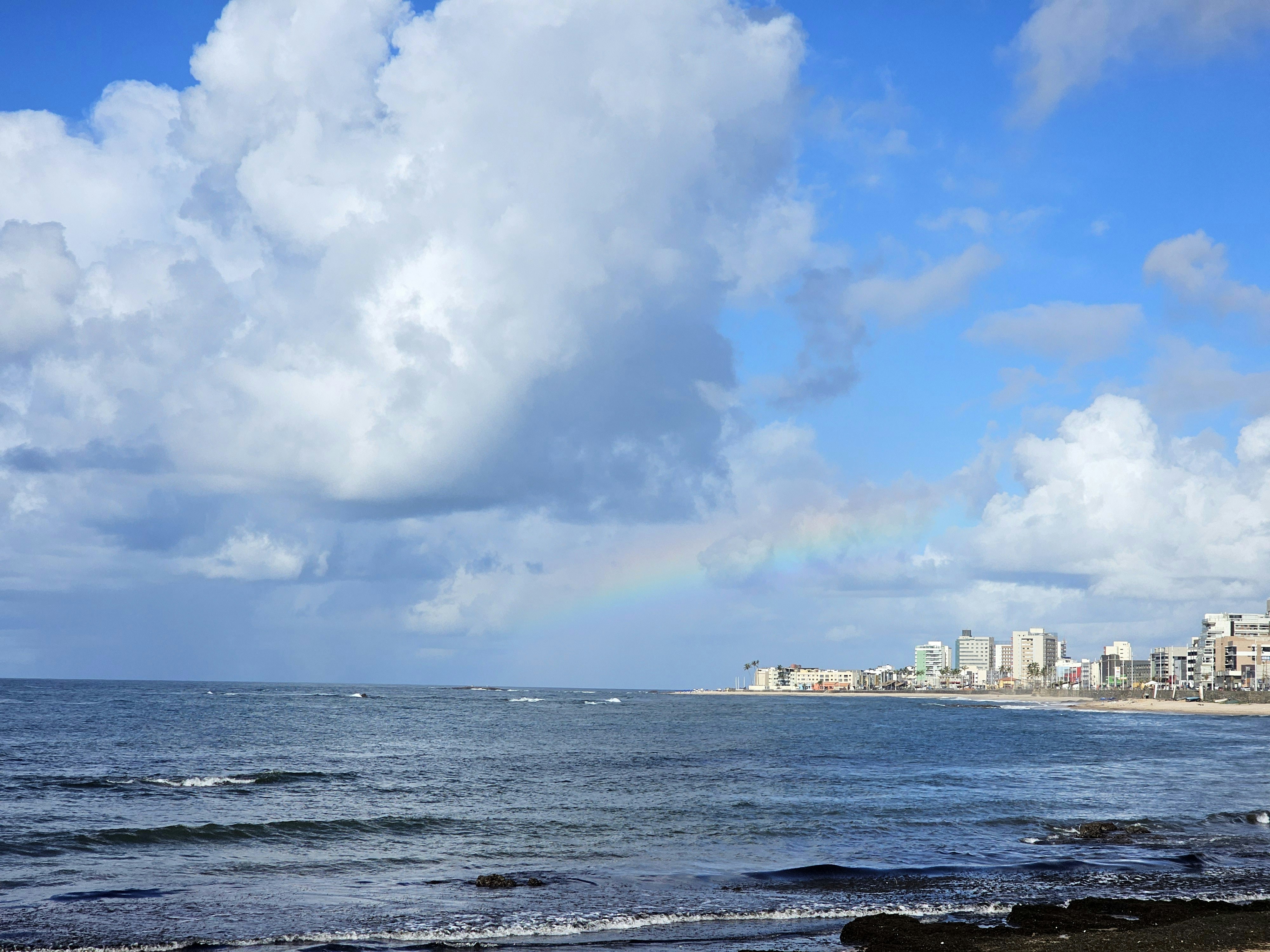 Rainbow over the coastal skyline as sea meets city