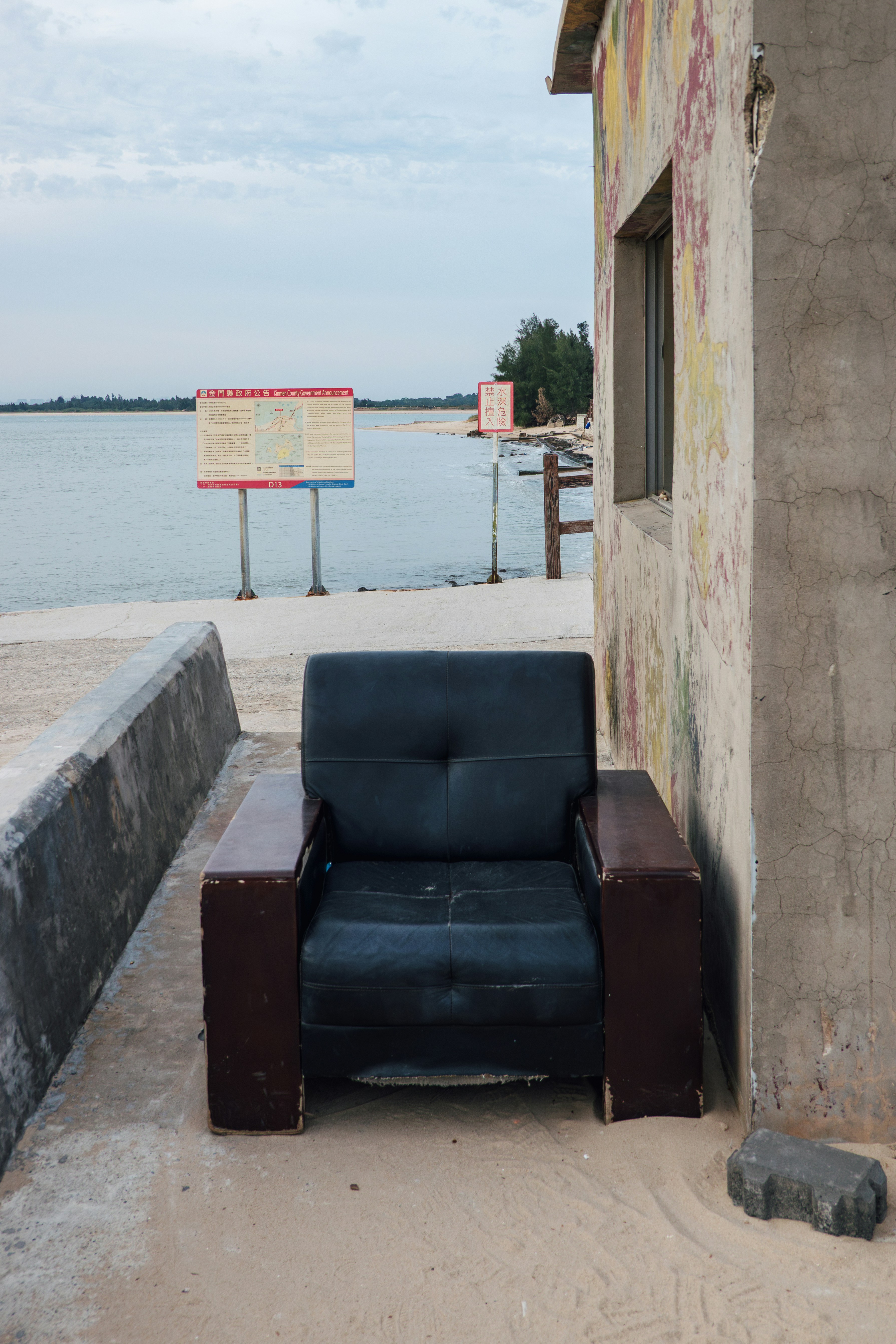 Seat by the Sea: A Quiet Corner Beneath a Weathered Wall