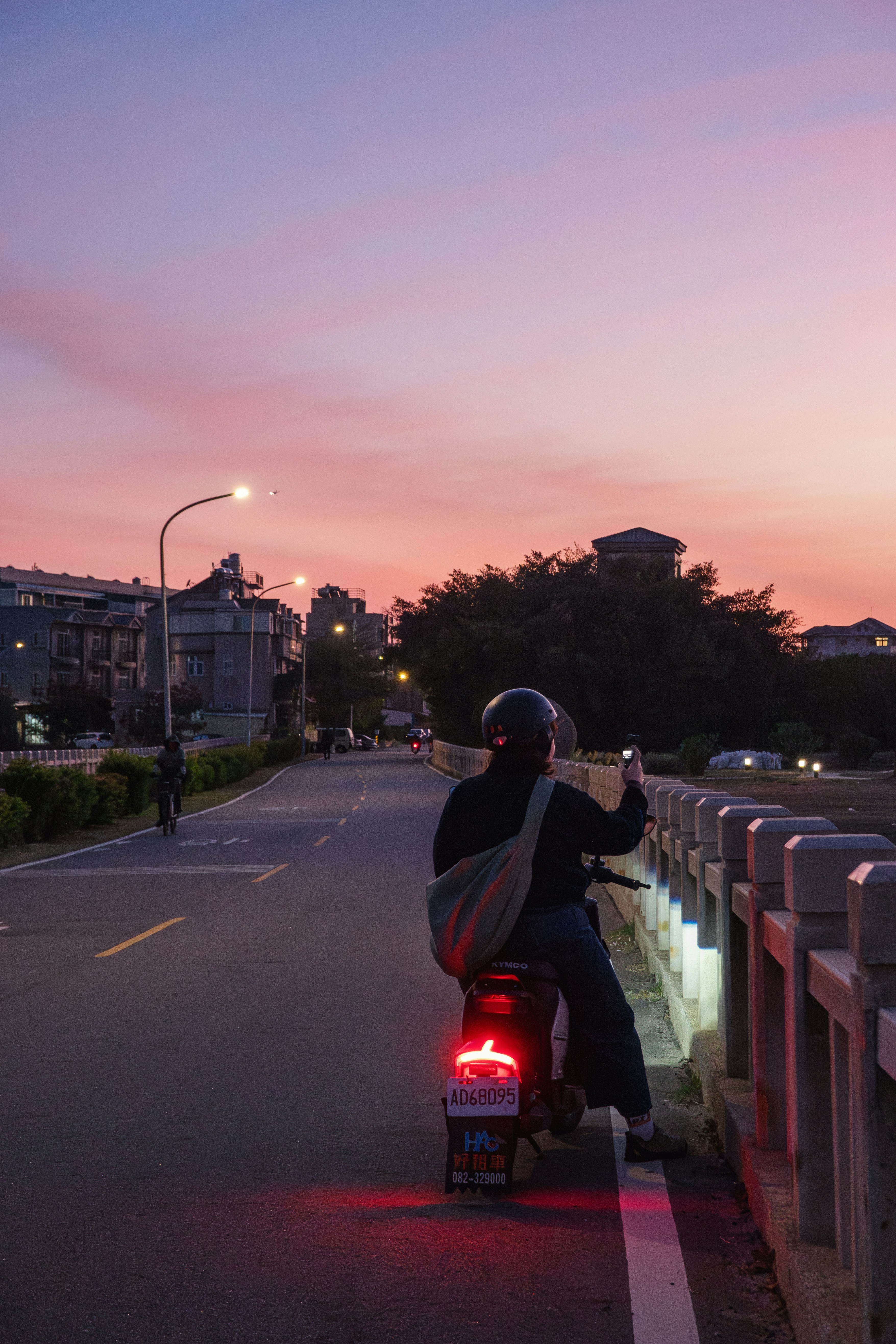 Evening Ride: Red Tail Light painted on a quiet boulevard