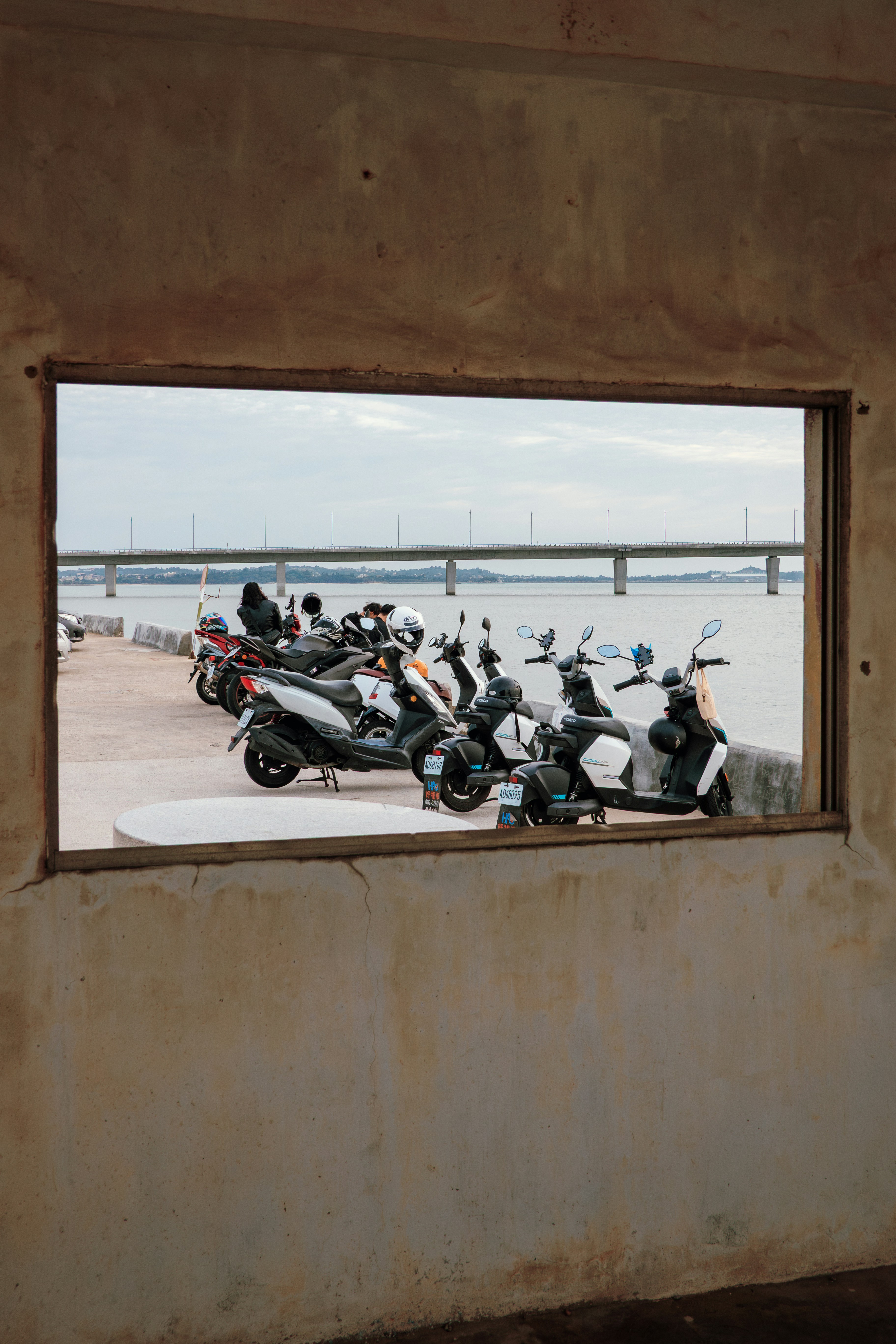 Scooters Framed by a Weathered Window