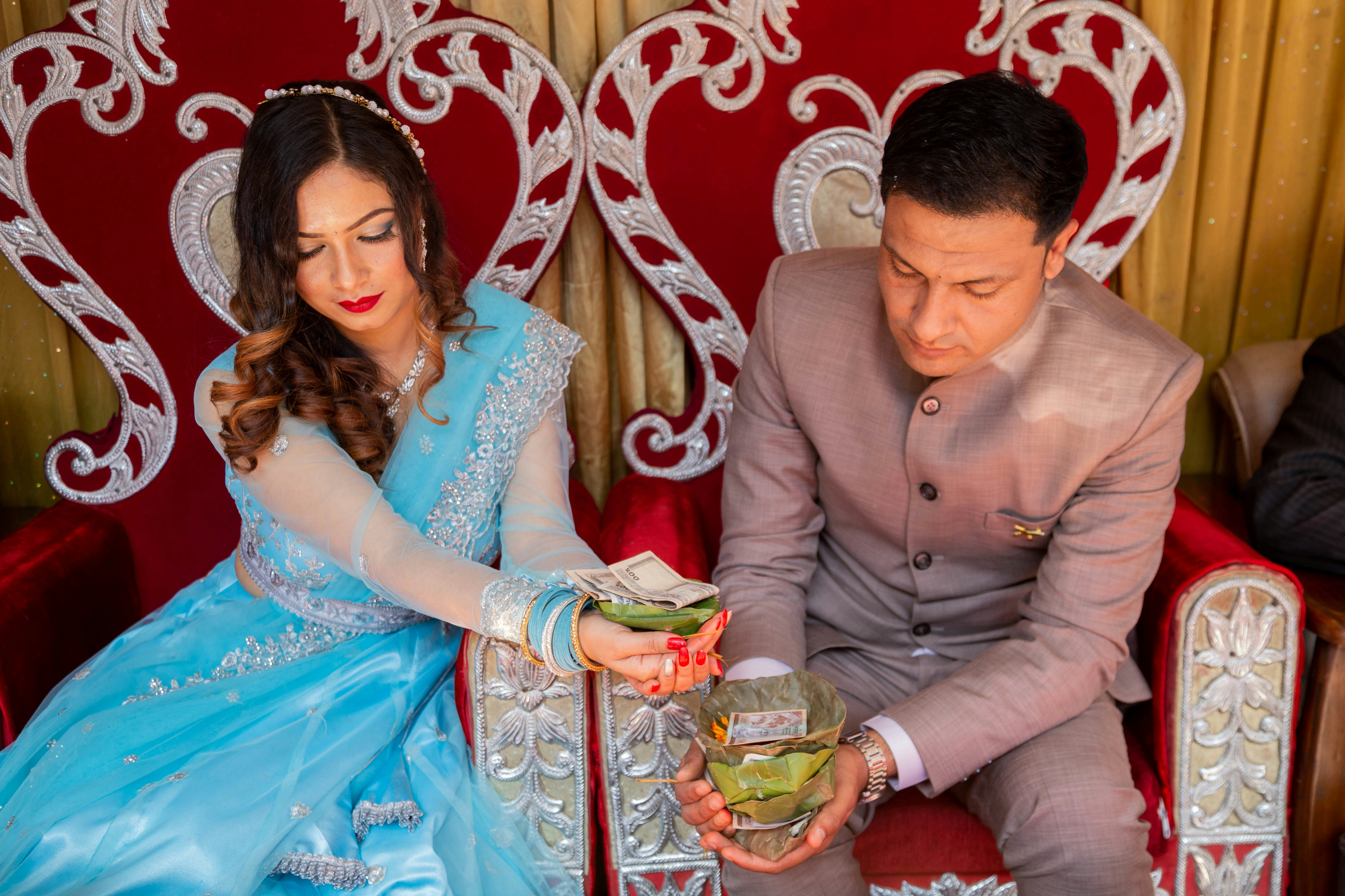 Exchange of Blessings: A Traditional Moment under Ornate Backdrops