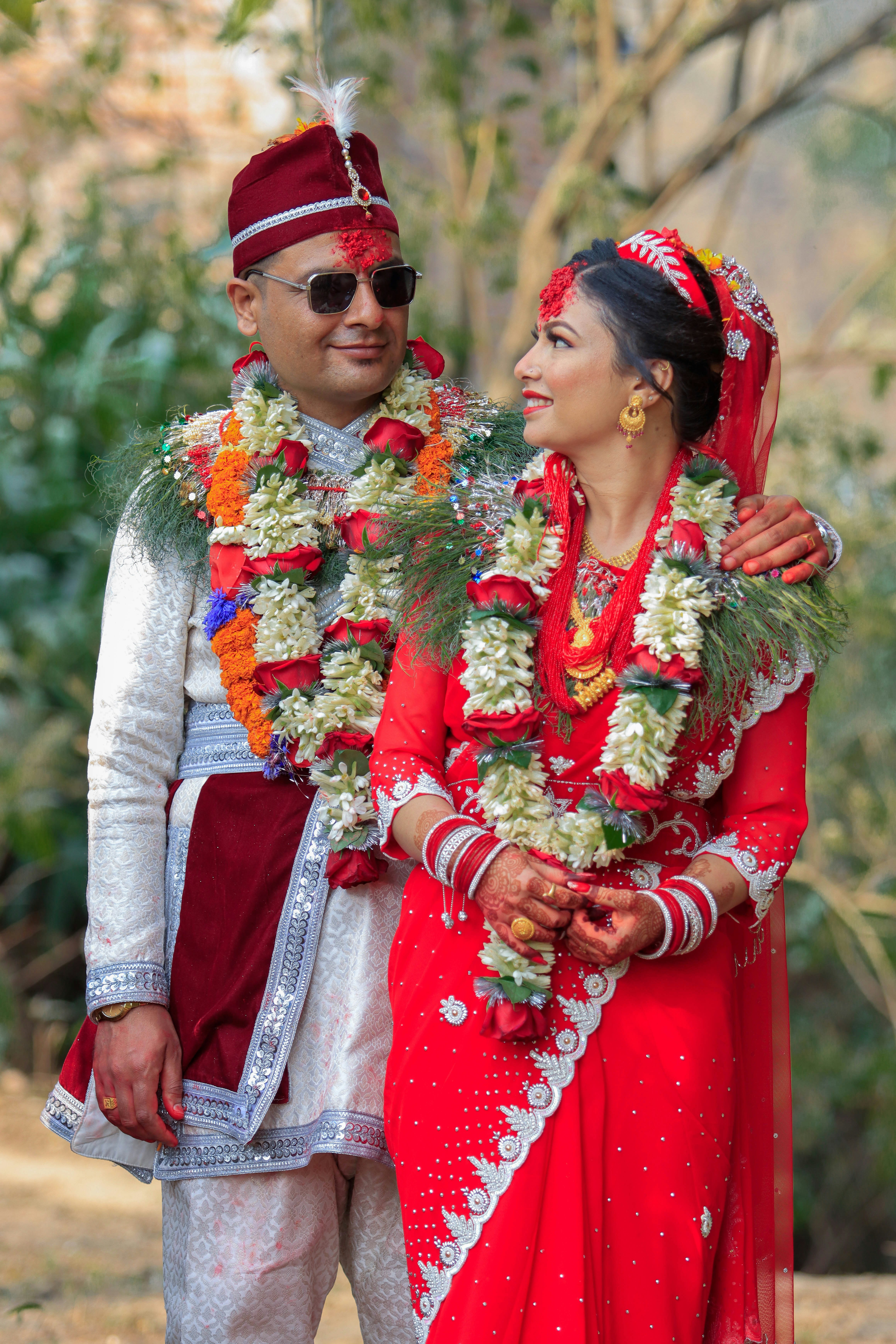 Red-Robed Unity: A Bride and Groom Share a Quiet Moment