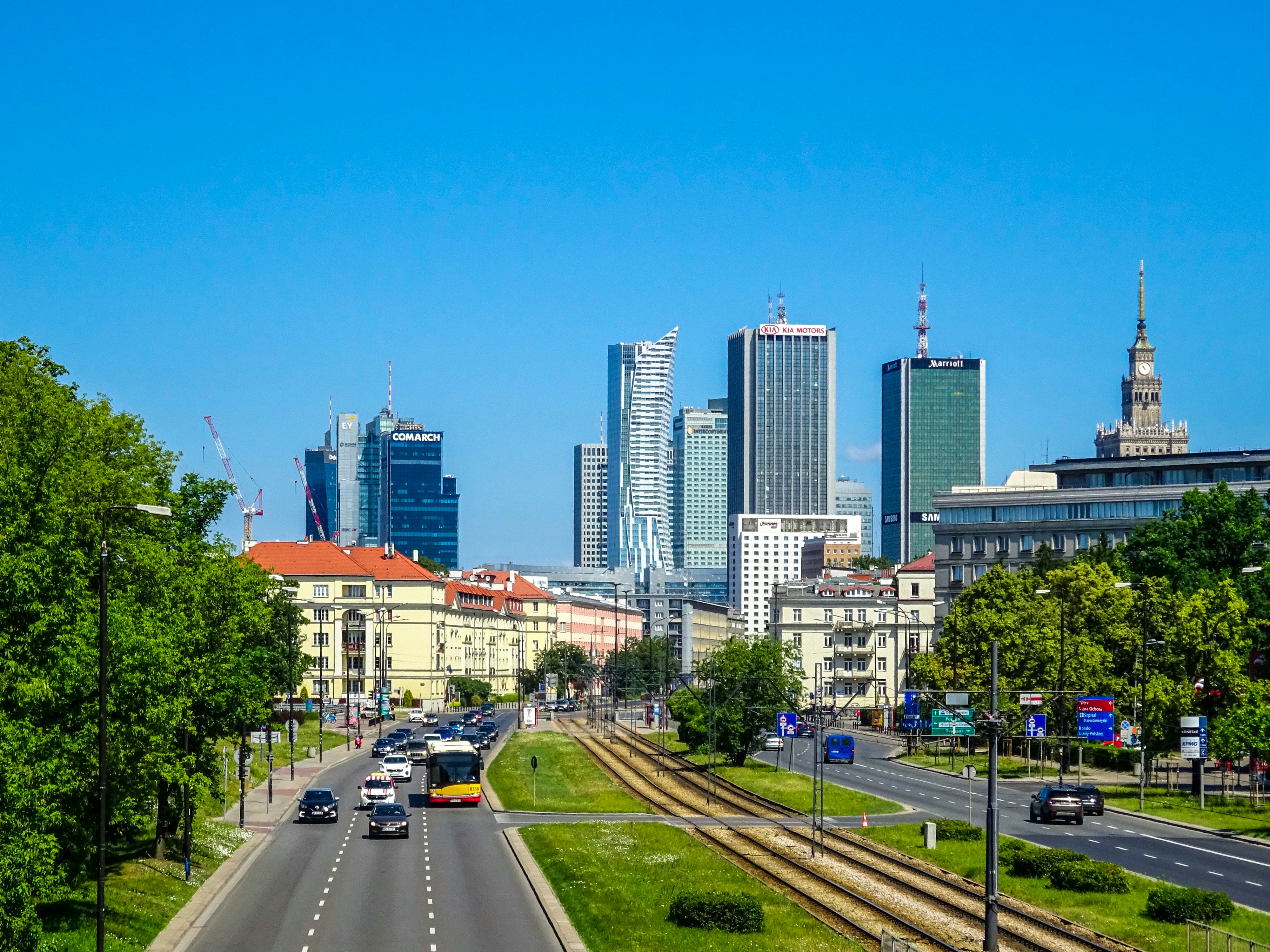 Modern cityscape with skyscrapers and green trees