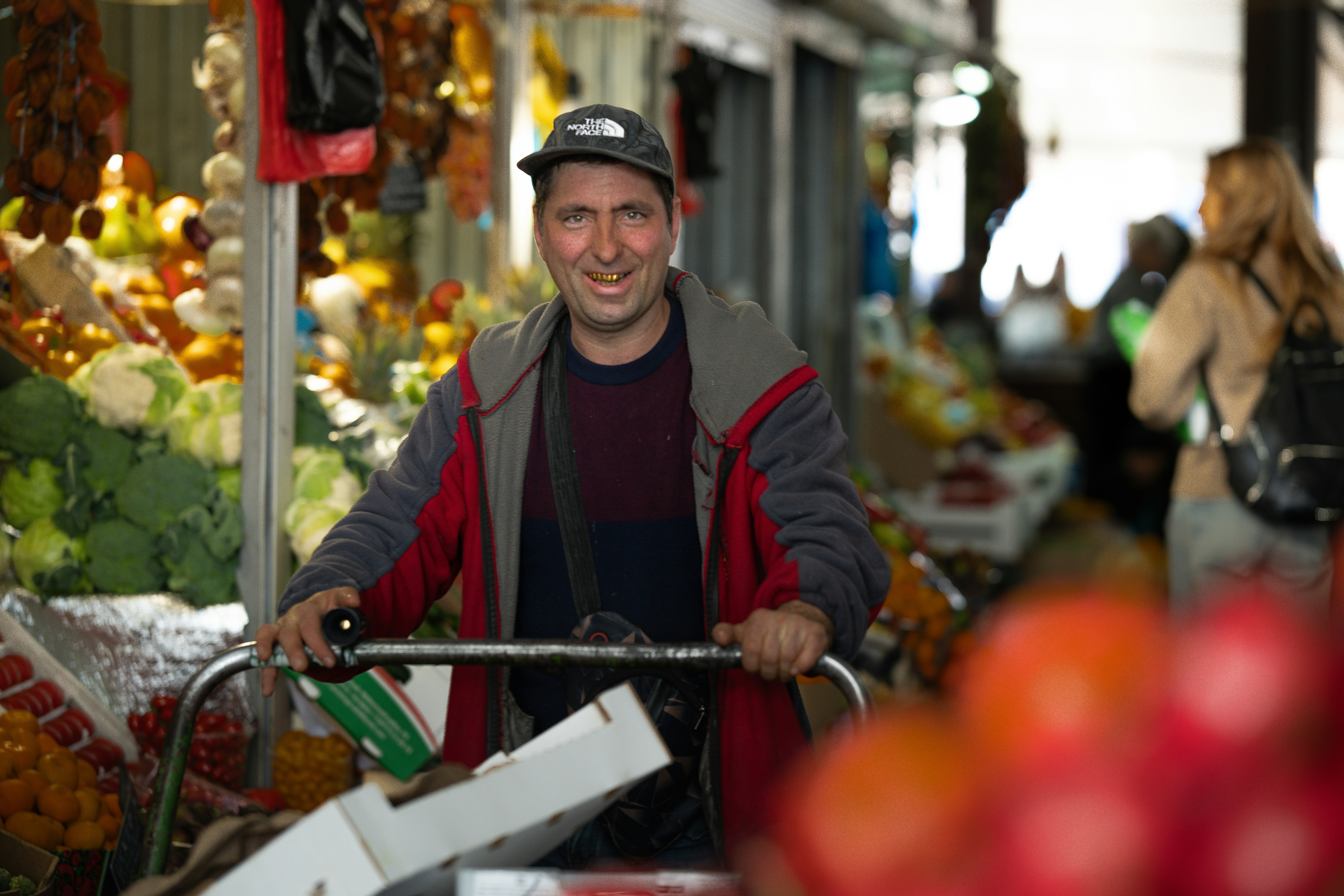 Man pushing a cart in a busy market