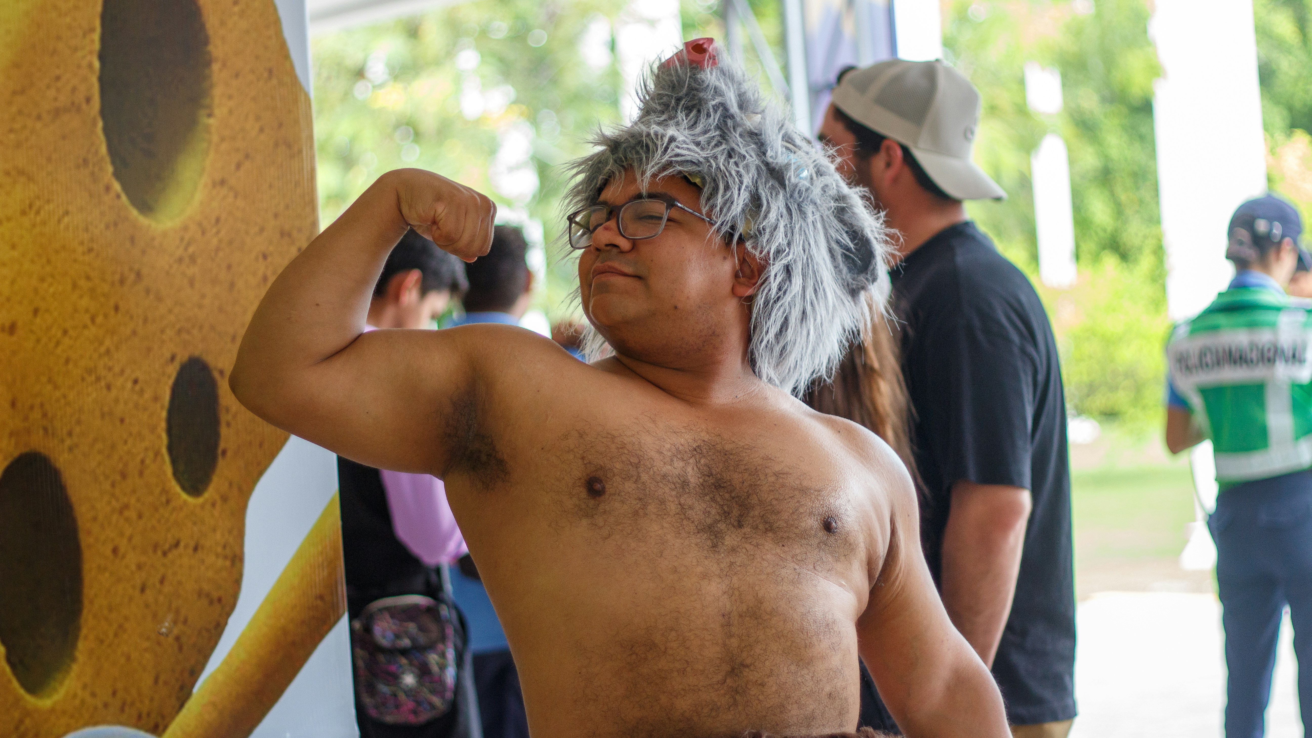 Muscle Pose in a Whimsical Costume at an Outdoor Event